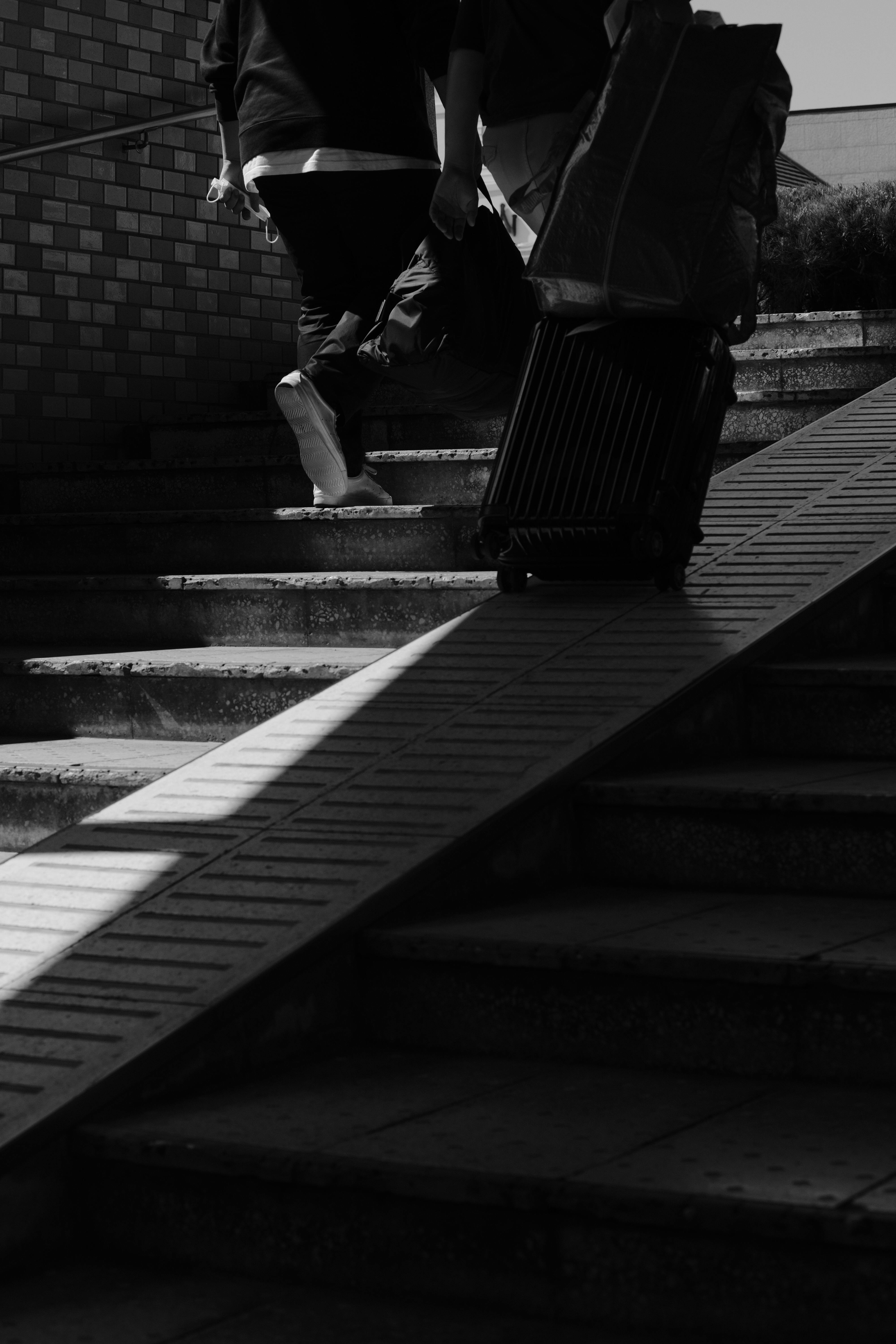 People Walking Upstairs and Towing Suitcases · Free Stock Photo