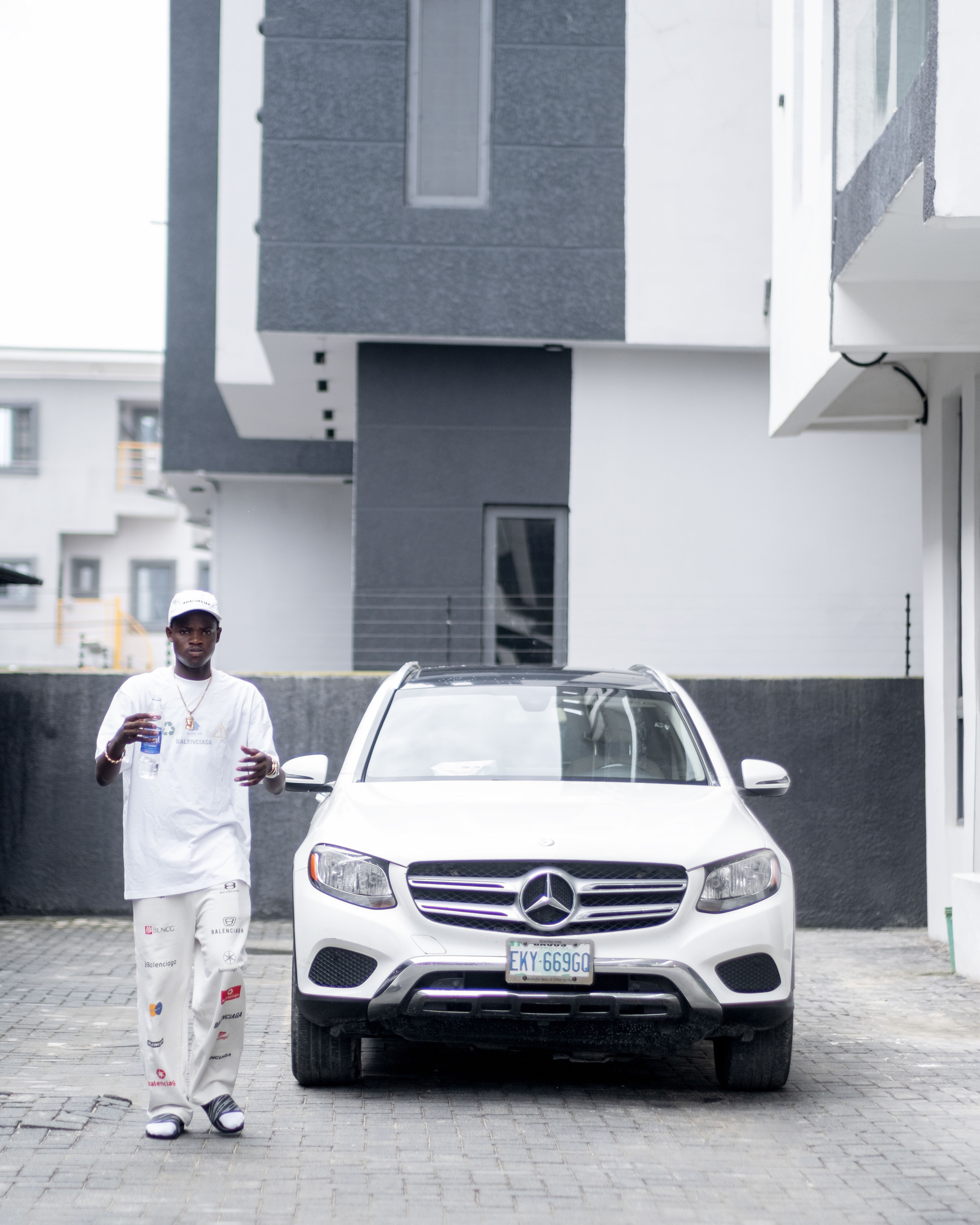 A man standing next to a mercedes benz · Free Stock Photo