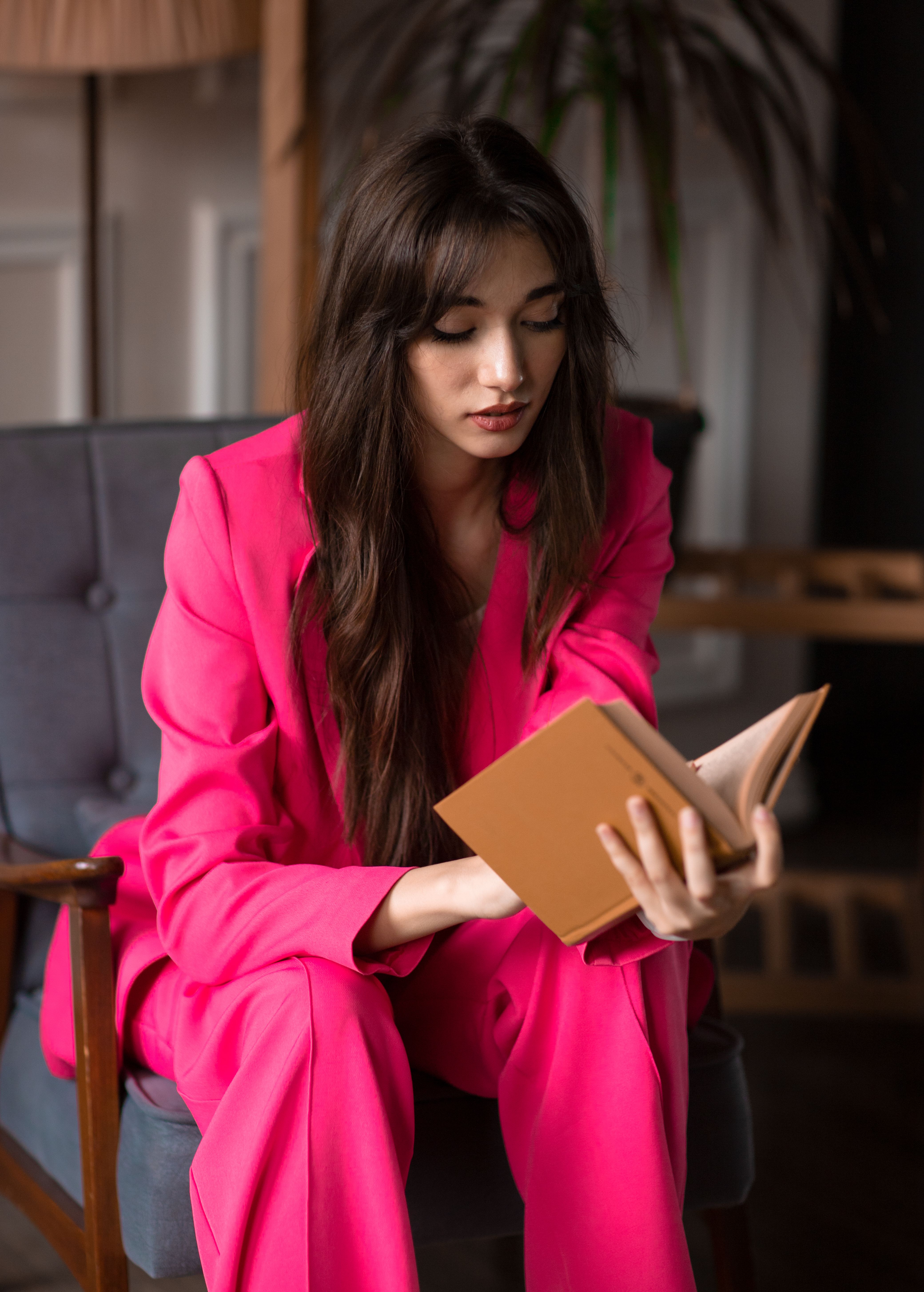 Woman Wearing Pink Suit Reading a Book · Free Stock Photo