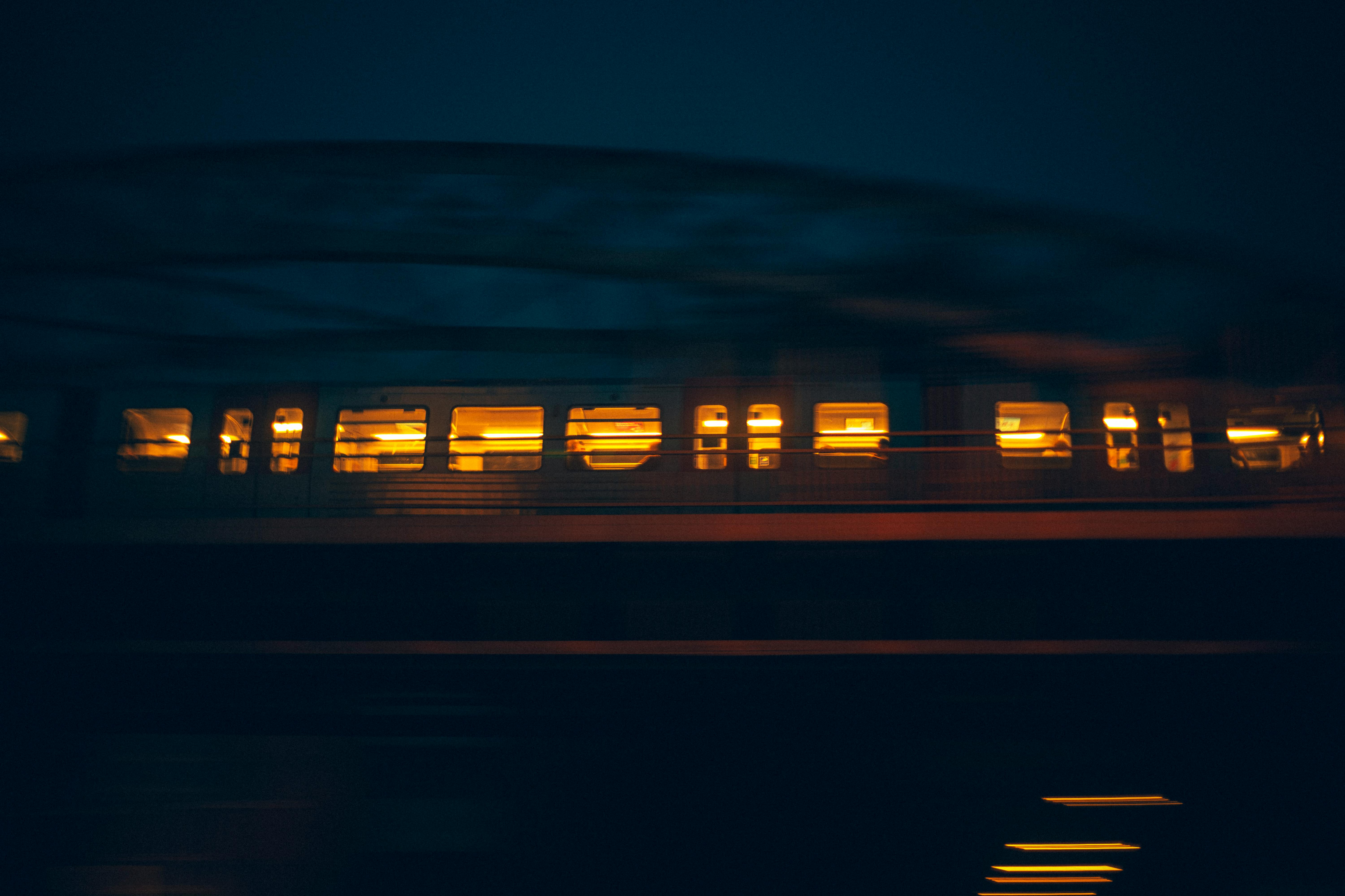 Illuminated Train on a Bridge at Night · Free Stock Photo