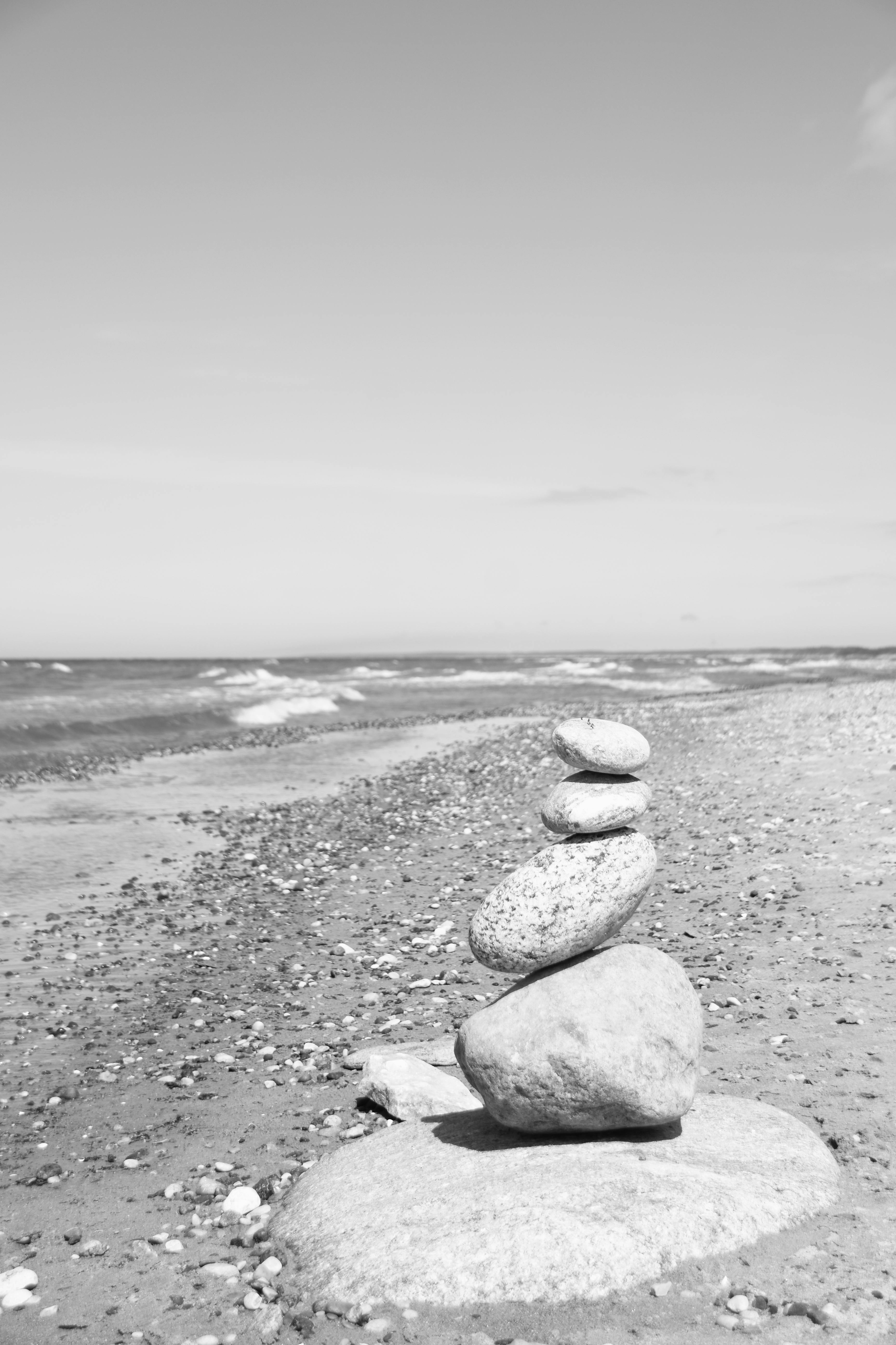 Cairn Stones and Body of Water in Distance · Free Stock Photo