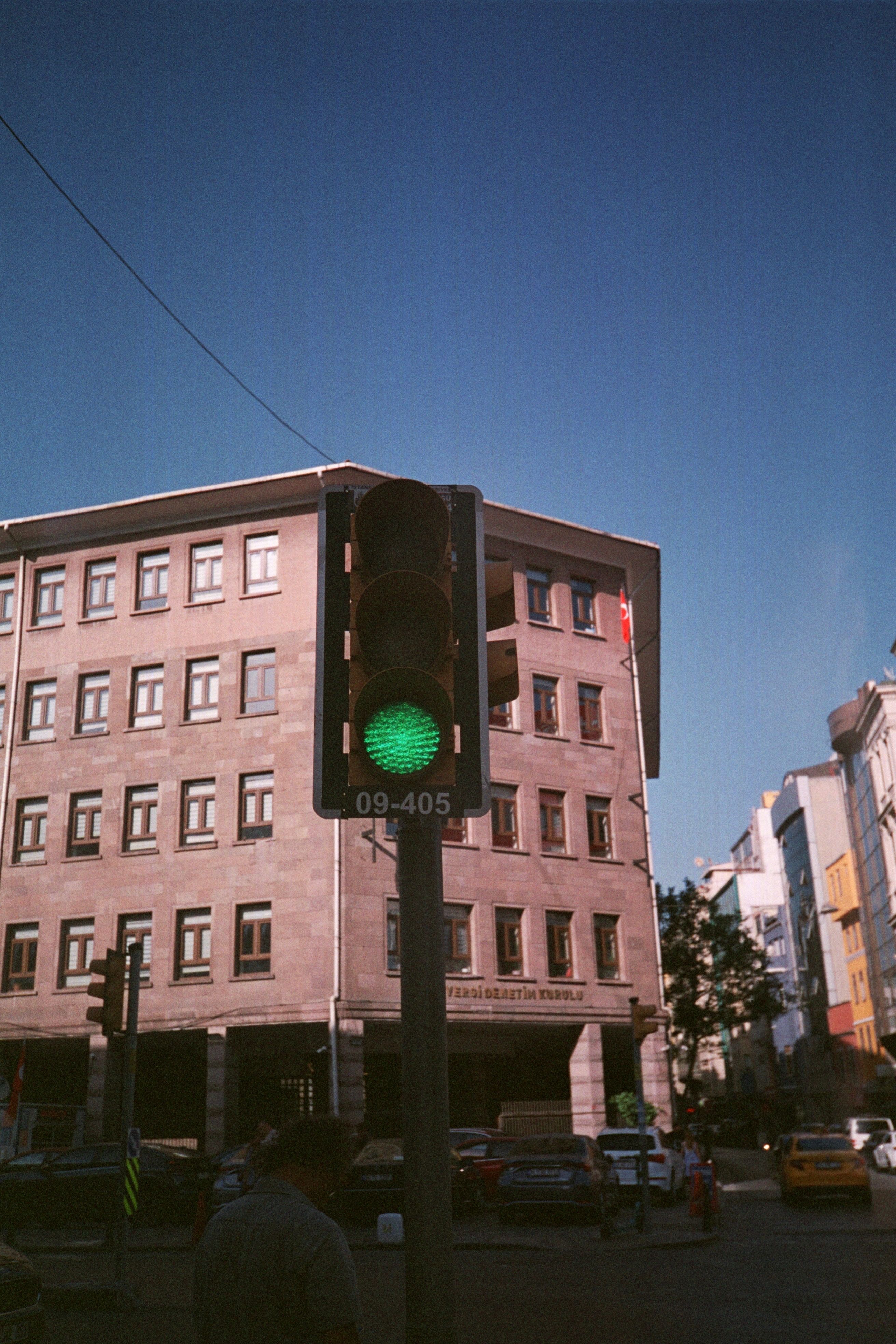 A green traffic light is on a street corner · Free Stock Photo