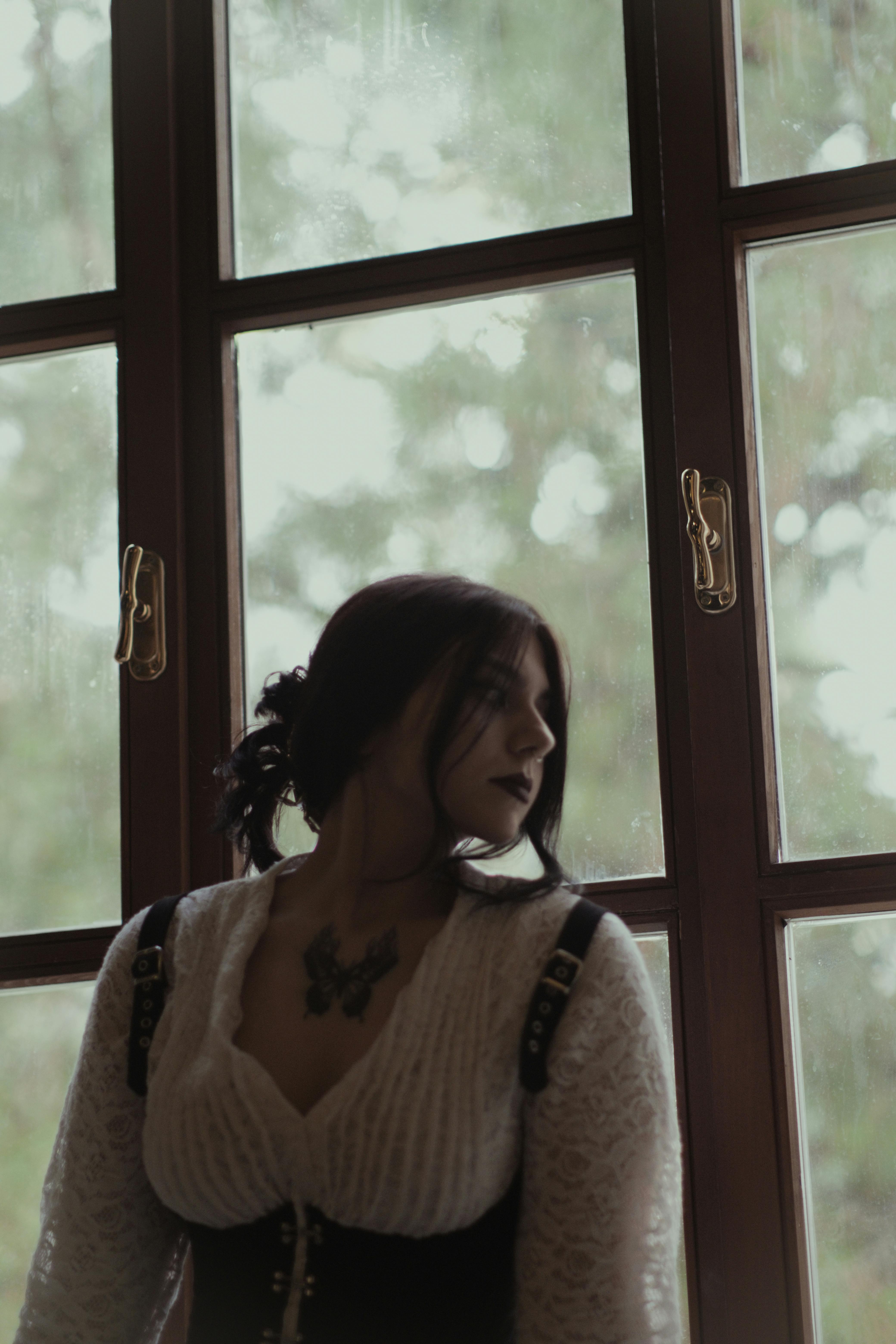 Woman Standing by Windows · Free Stock Photo