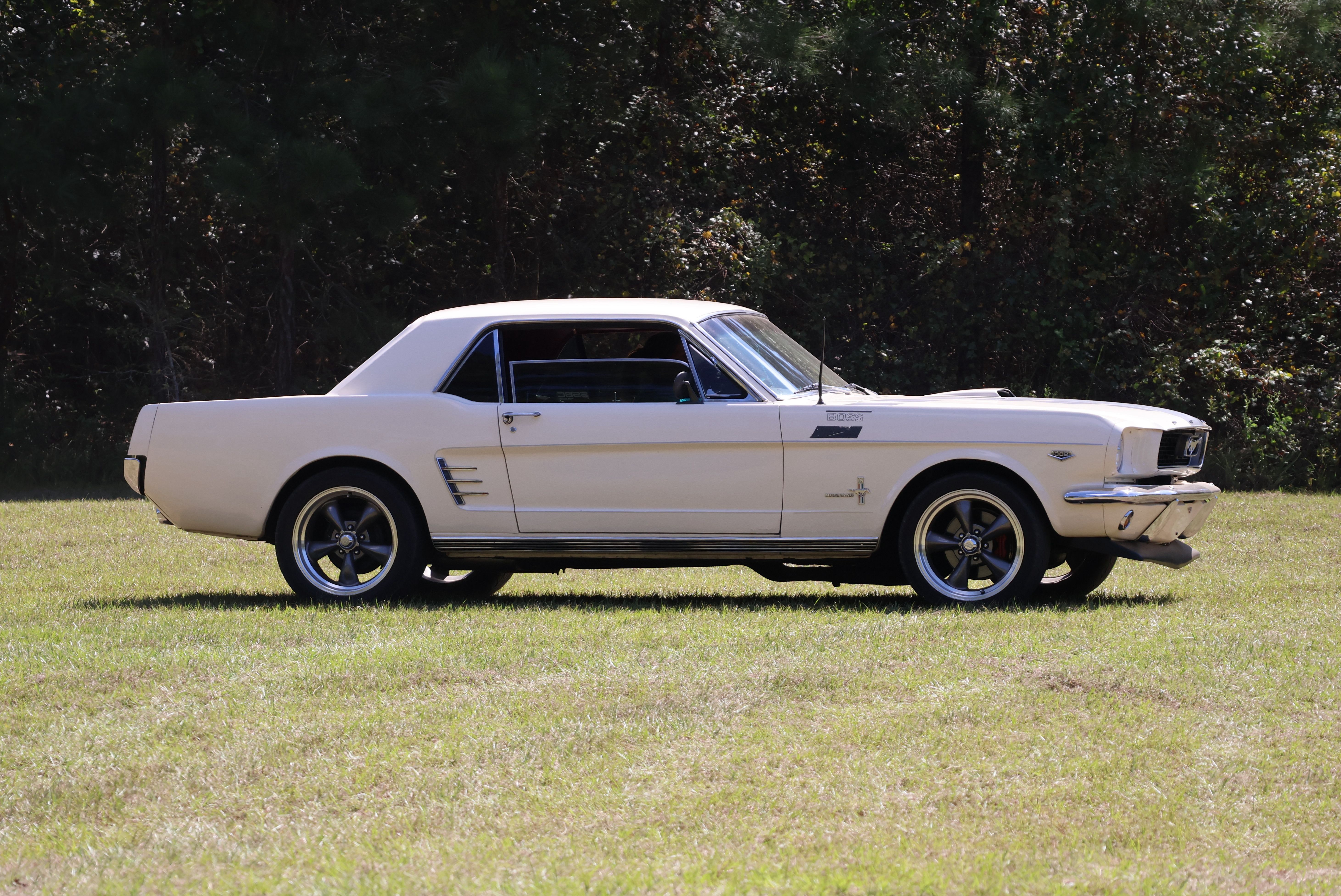 White Vintage Ford Mustang in a Grass Field · Free Stock Photo