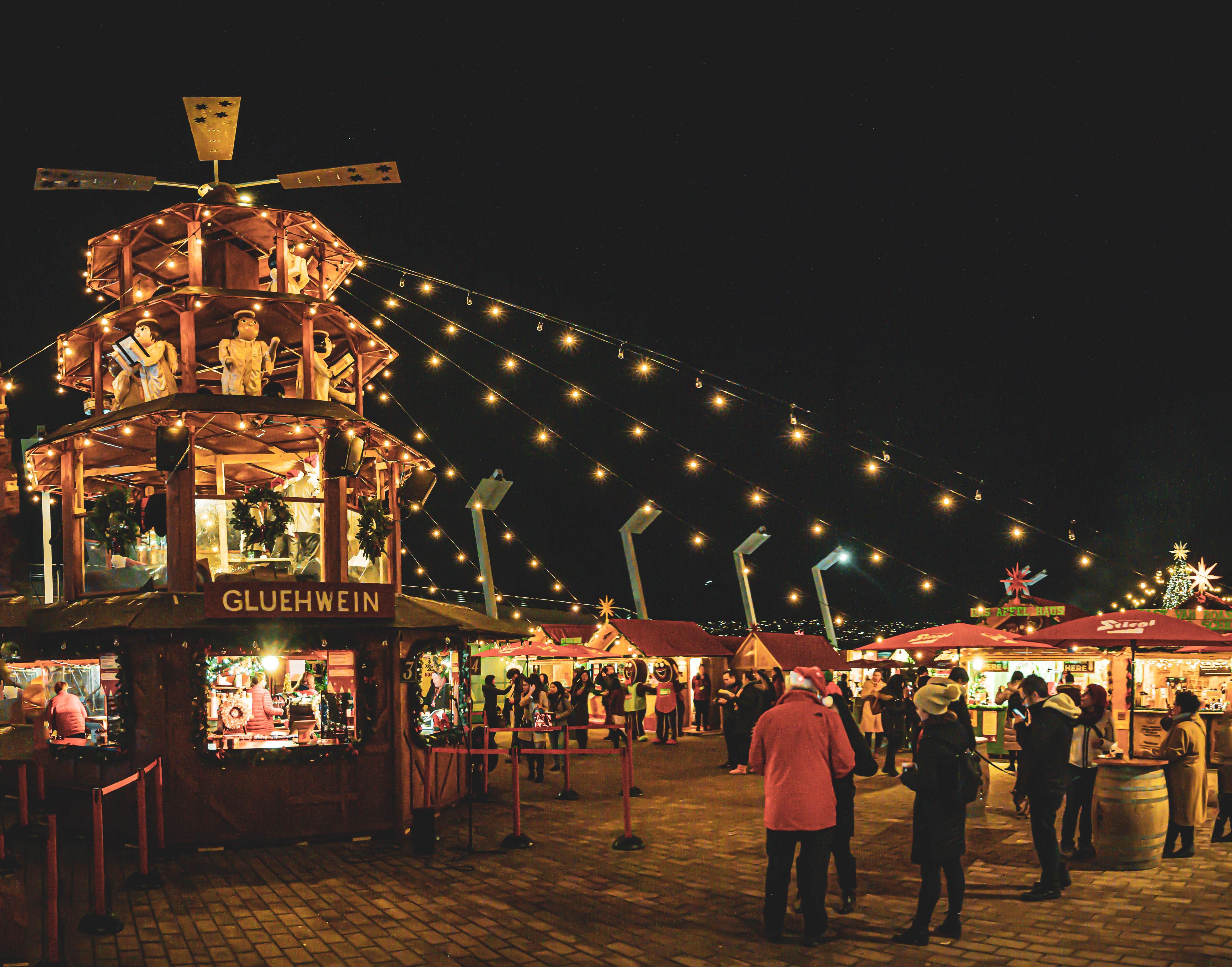 A christmas market with lights and people · Free Stock Photo