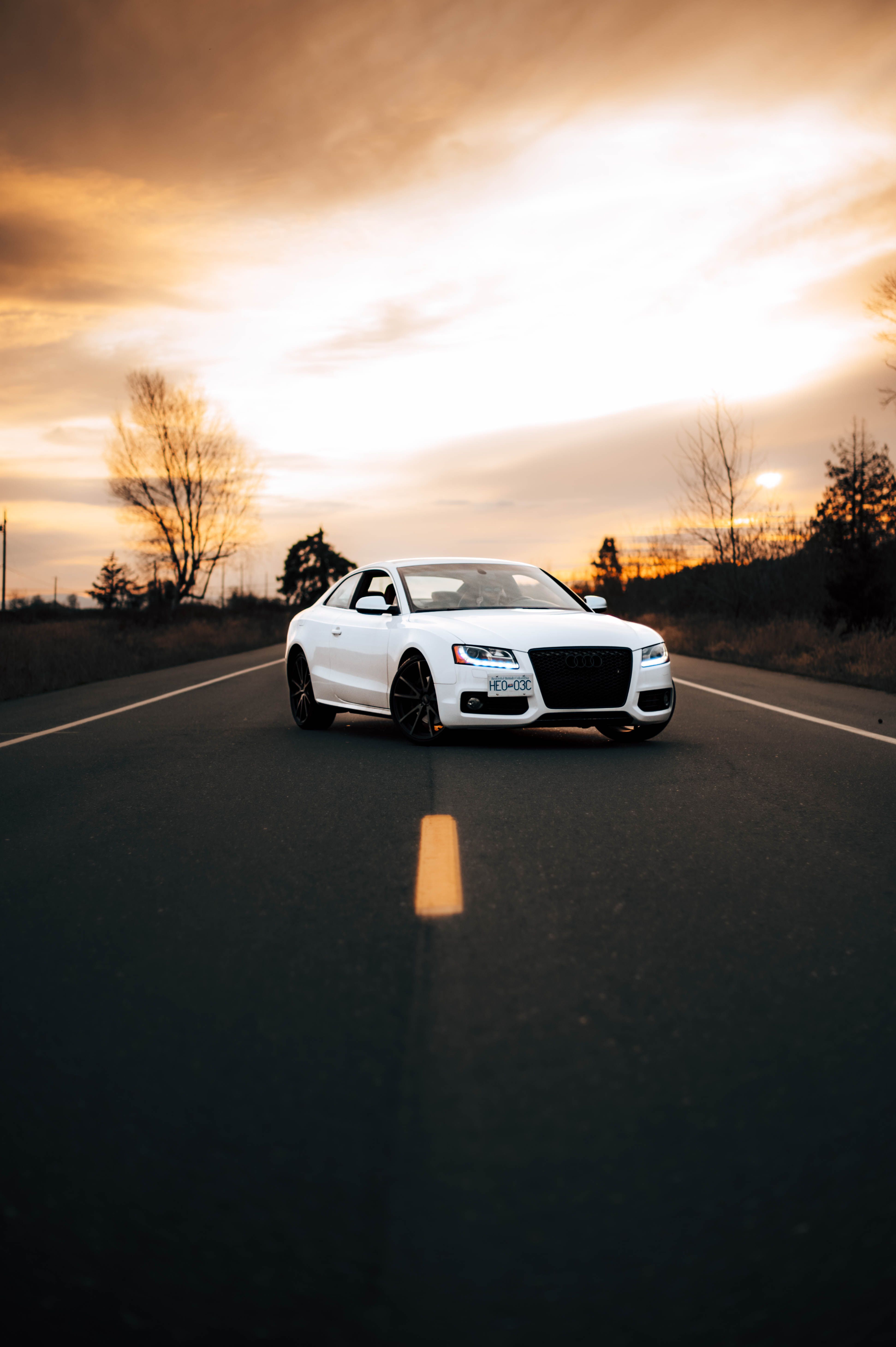 A white car on the road at sunset · Free Stock Photo