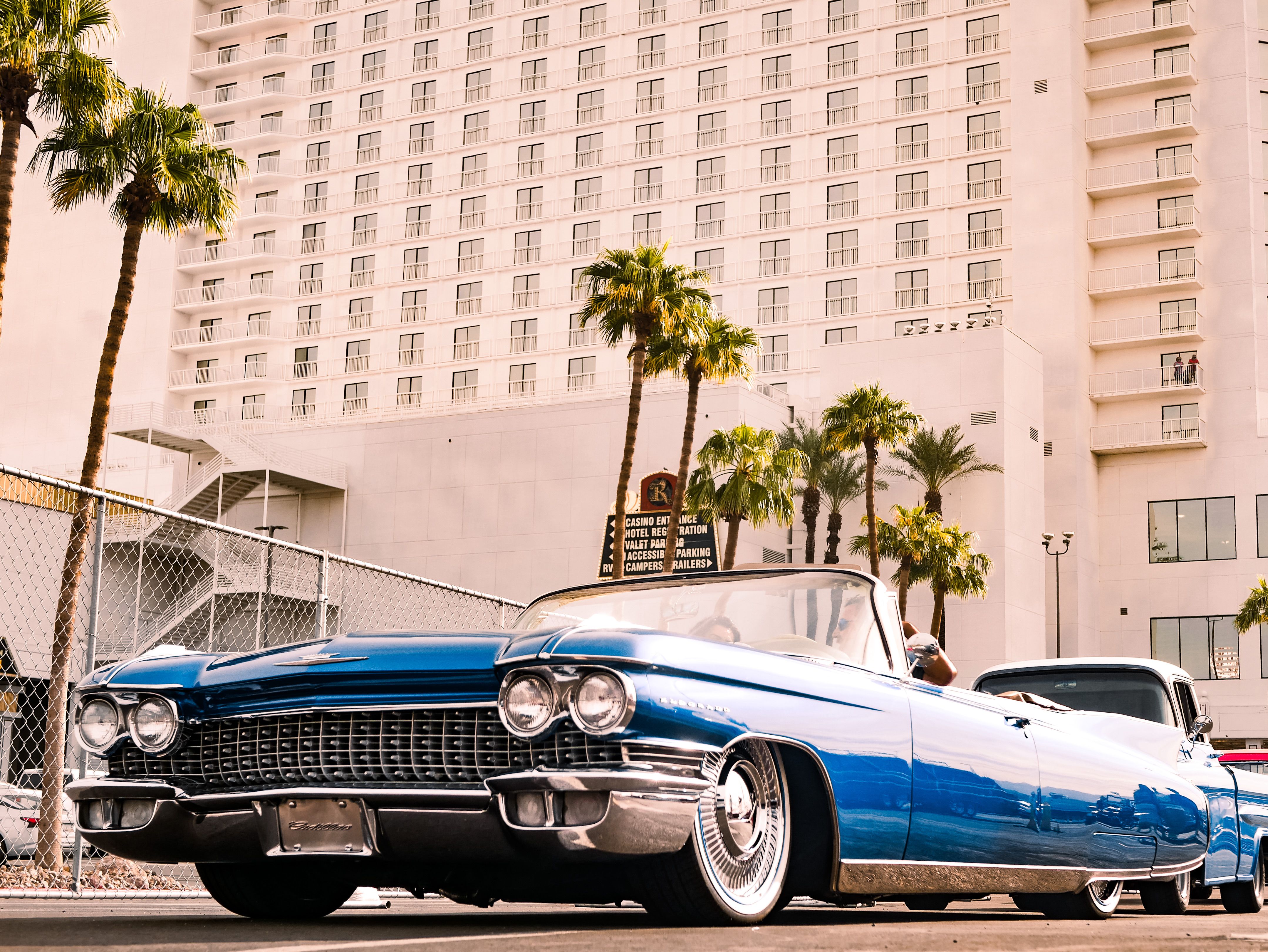 A classic car parked in front of a hotel · Free Stock Photo