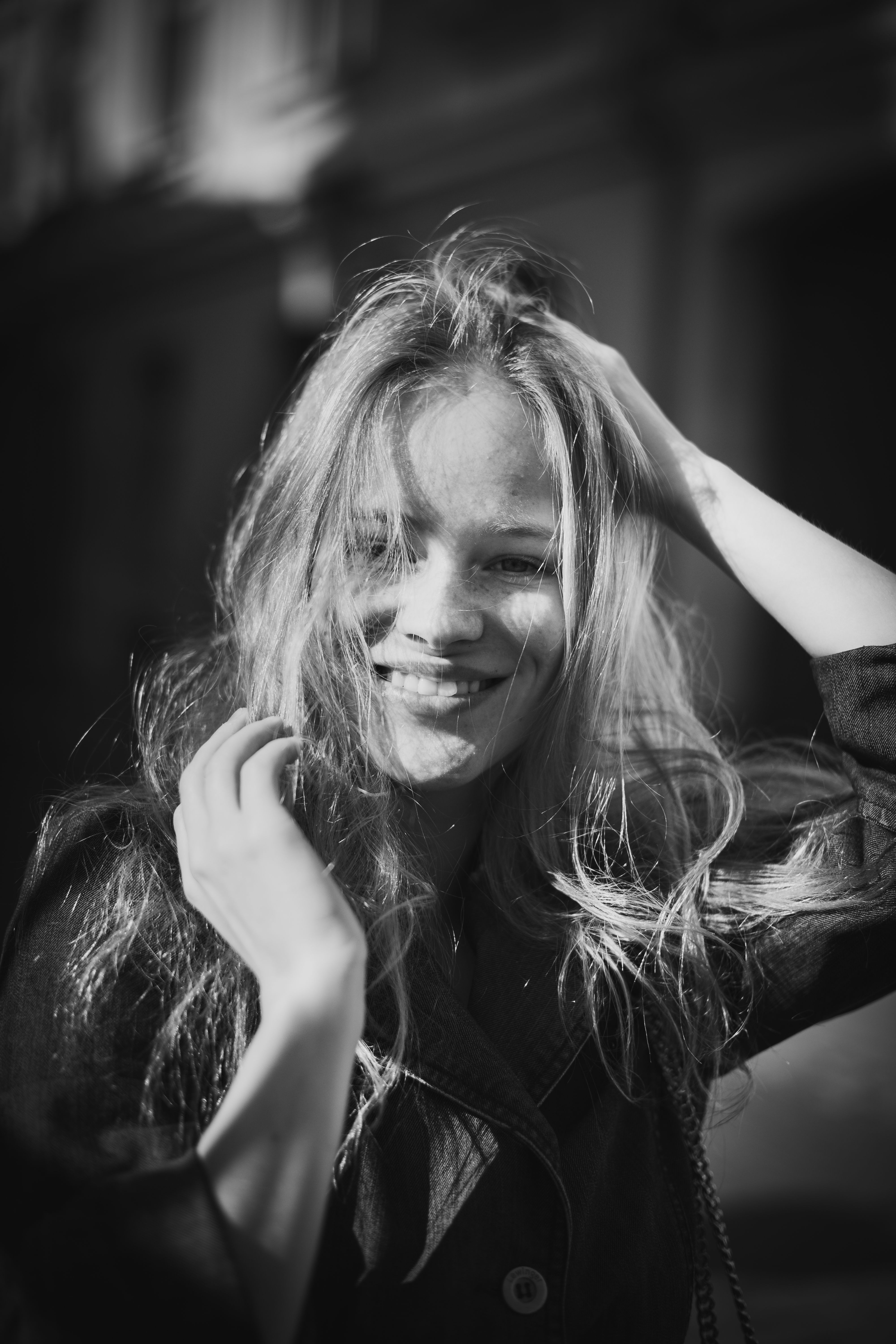 Smiling Woman is Tousling Hair · Free Stock Photo