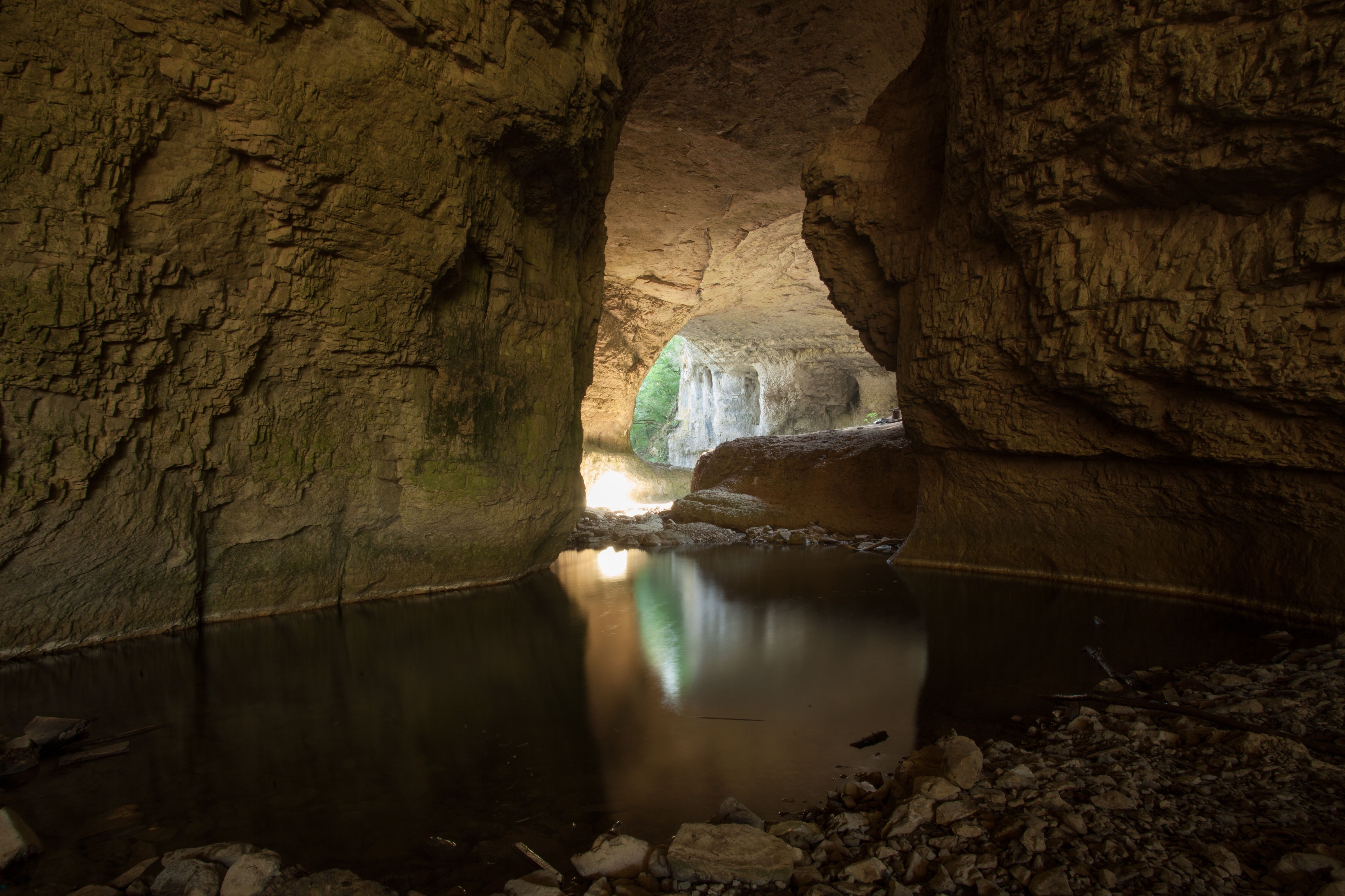A cave with water in it and a rock · Free Stock Photo