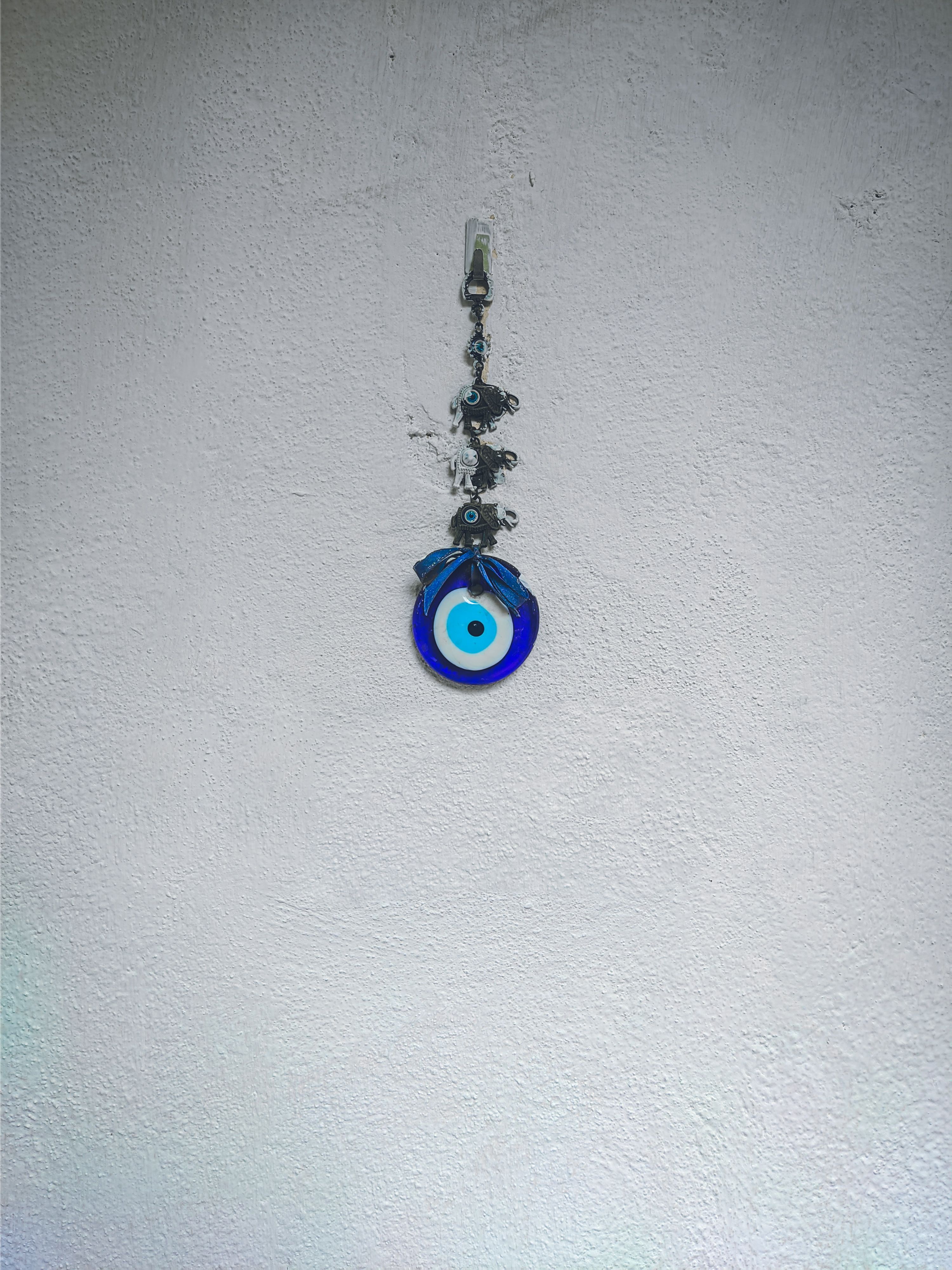 Evil Eye Decorations Hanging on City Street · Free Stock Photo