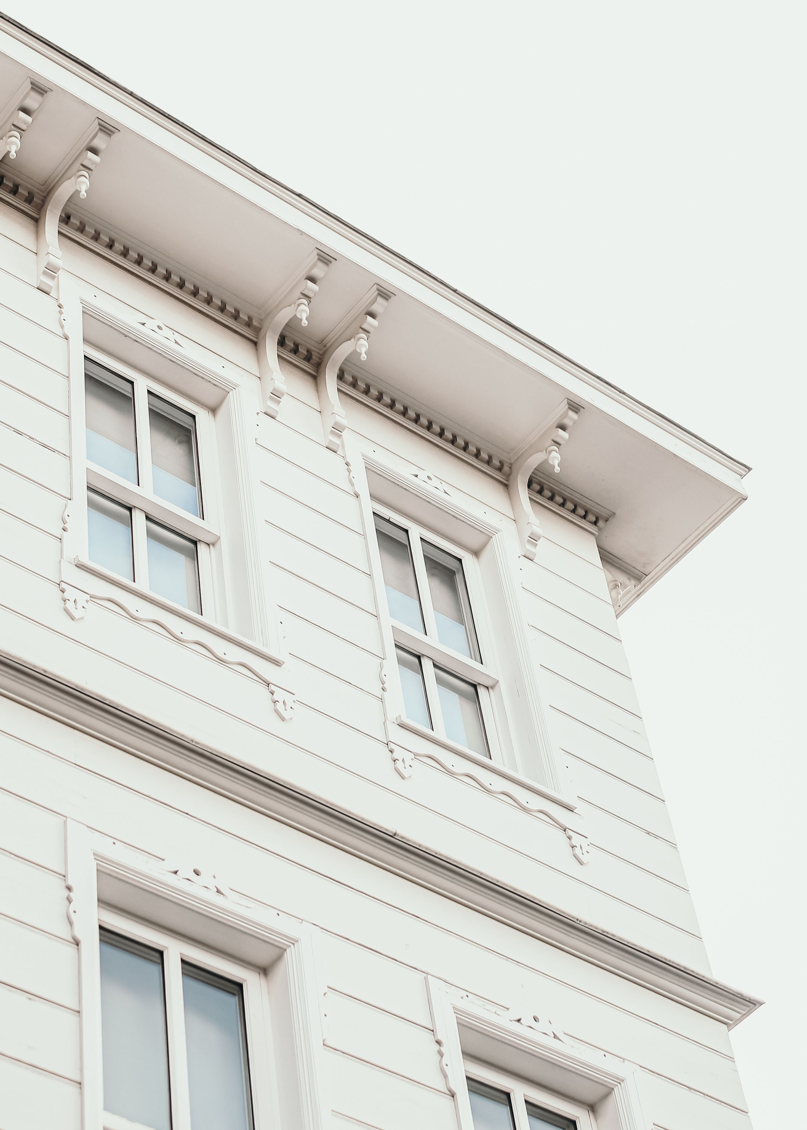 A white building with windows and a balcony · Free Stock Photo