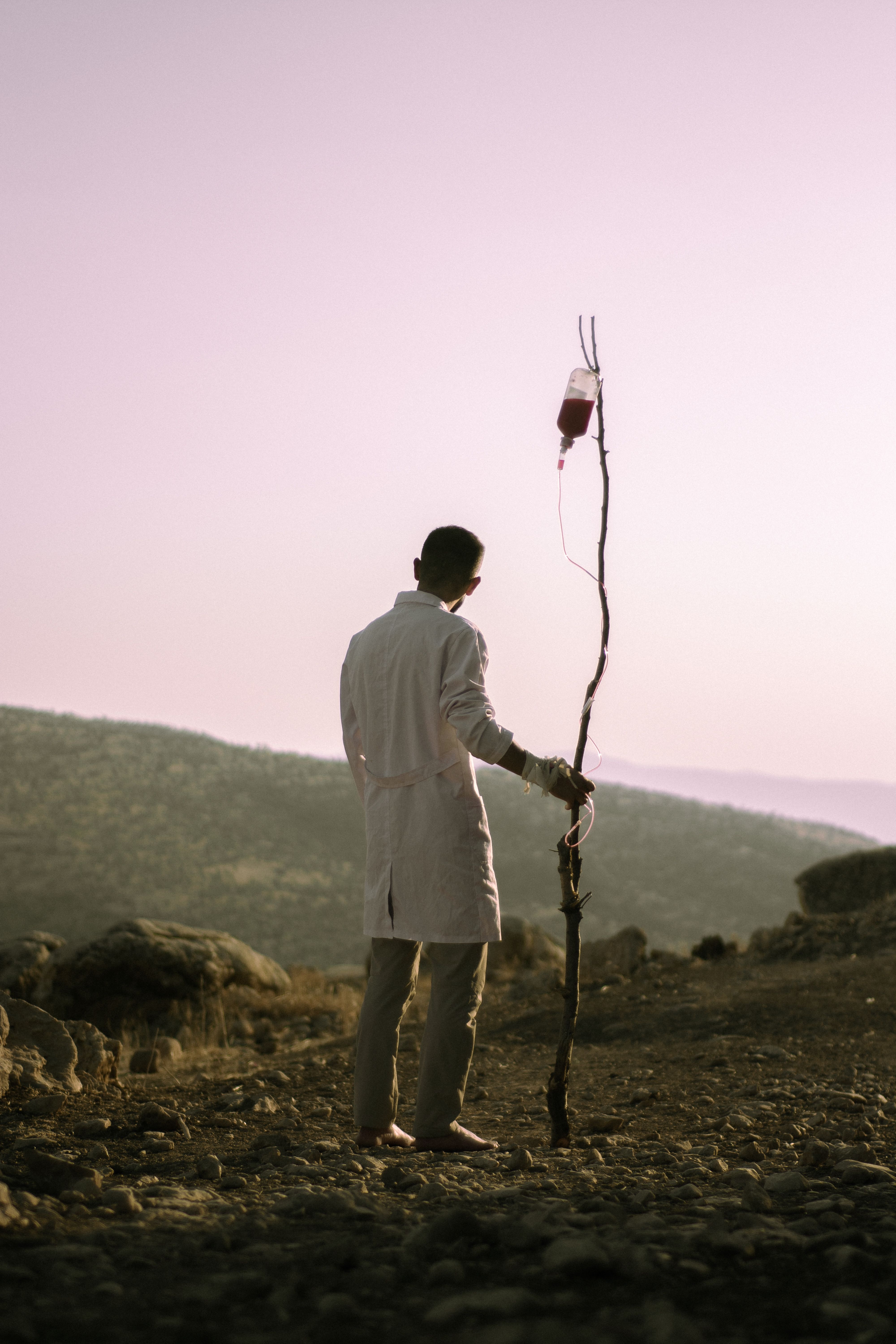 Man With a Drip in a Mountain Valley · Free Stock Photo