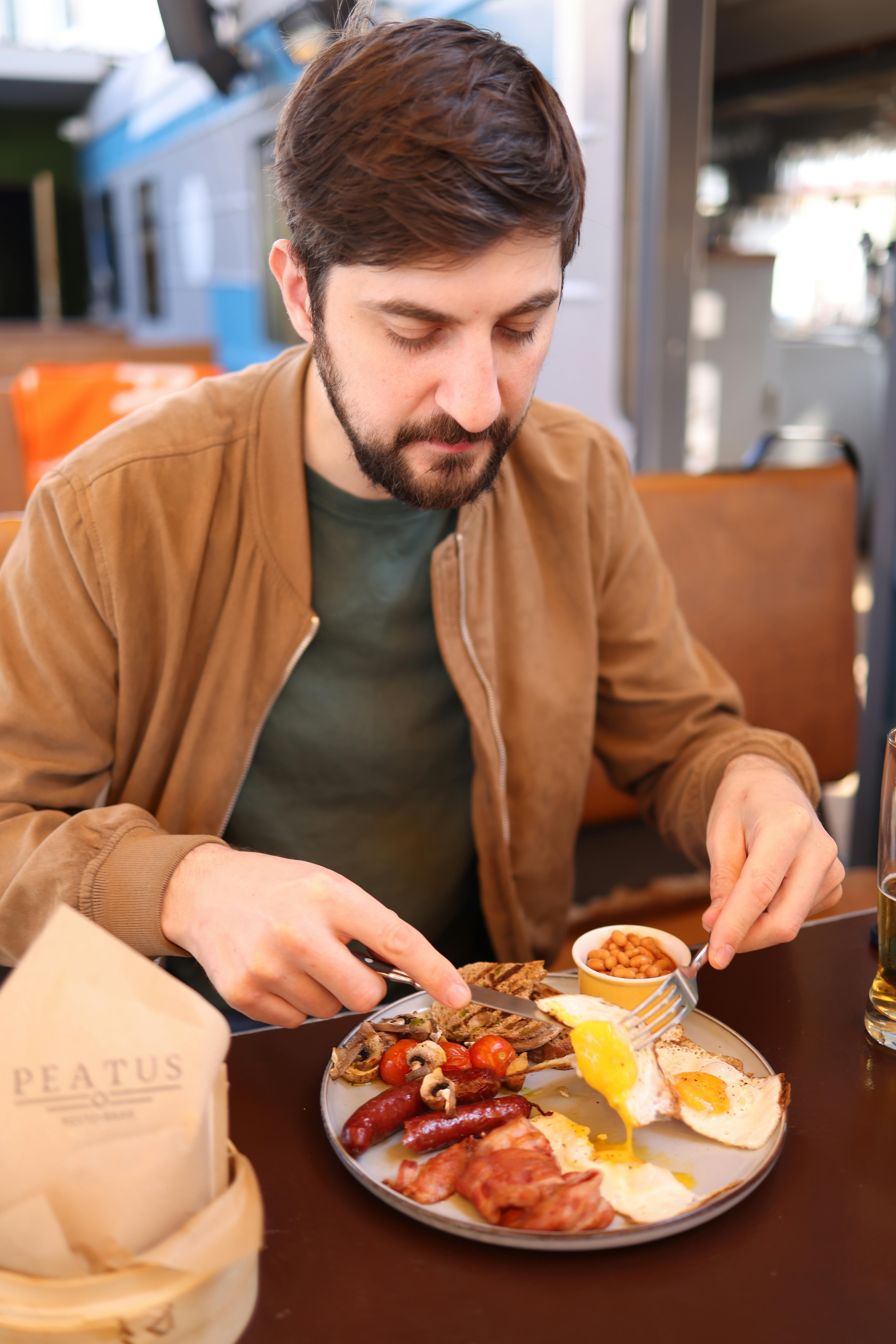 Man Eating Full English Breakfast at Restaurant · Free Stock Photo