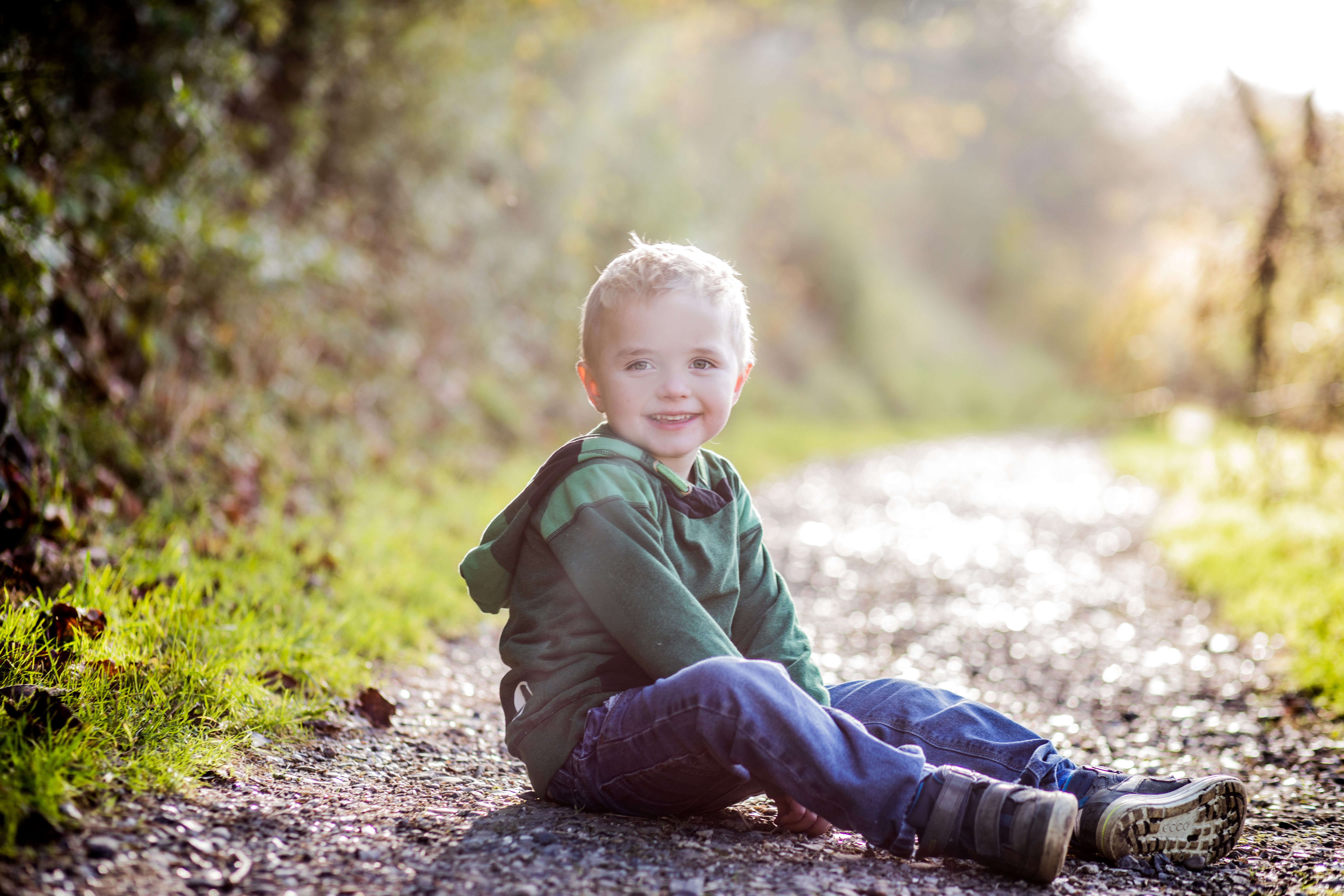 Boy Sitting On Ground · Free Stock Photo
