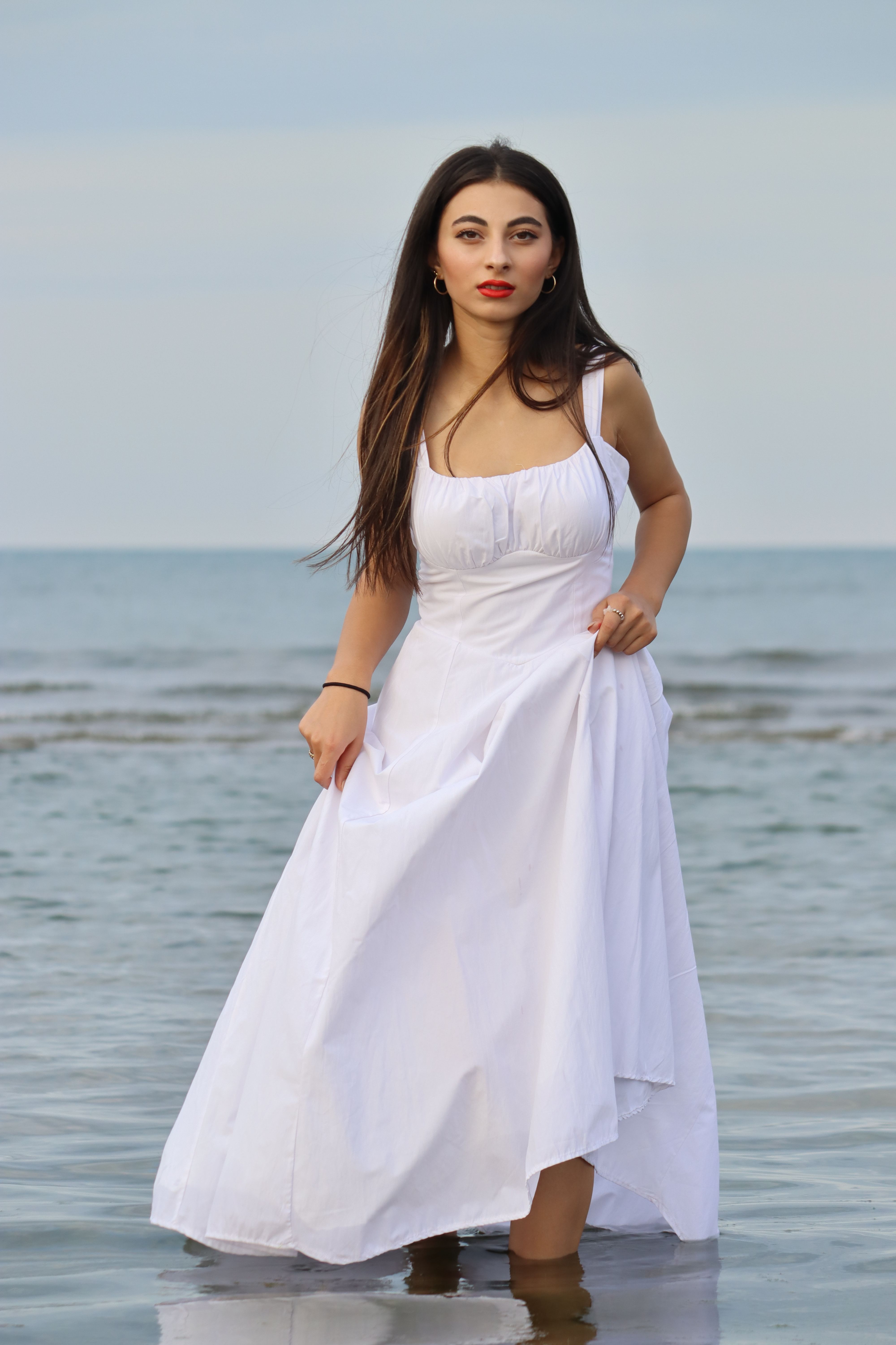 Model in a White Square Neck Sundress Walking in Ankle Deep Water ...