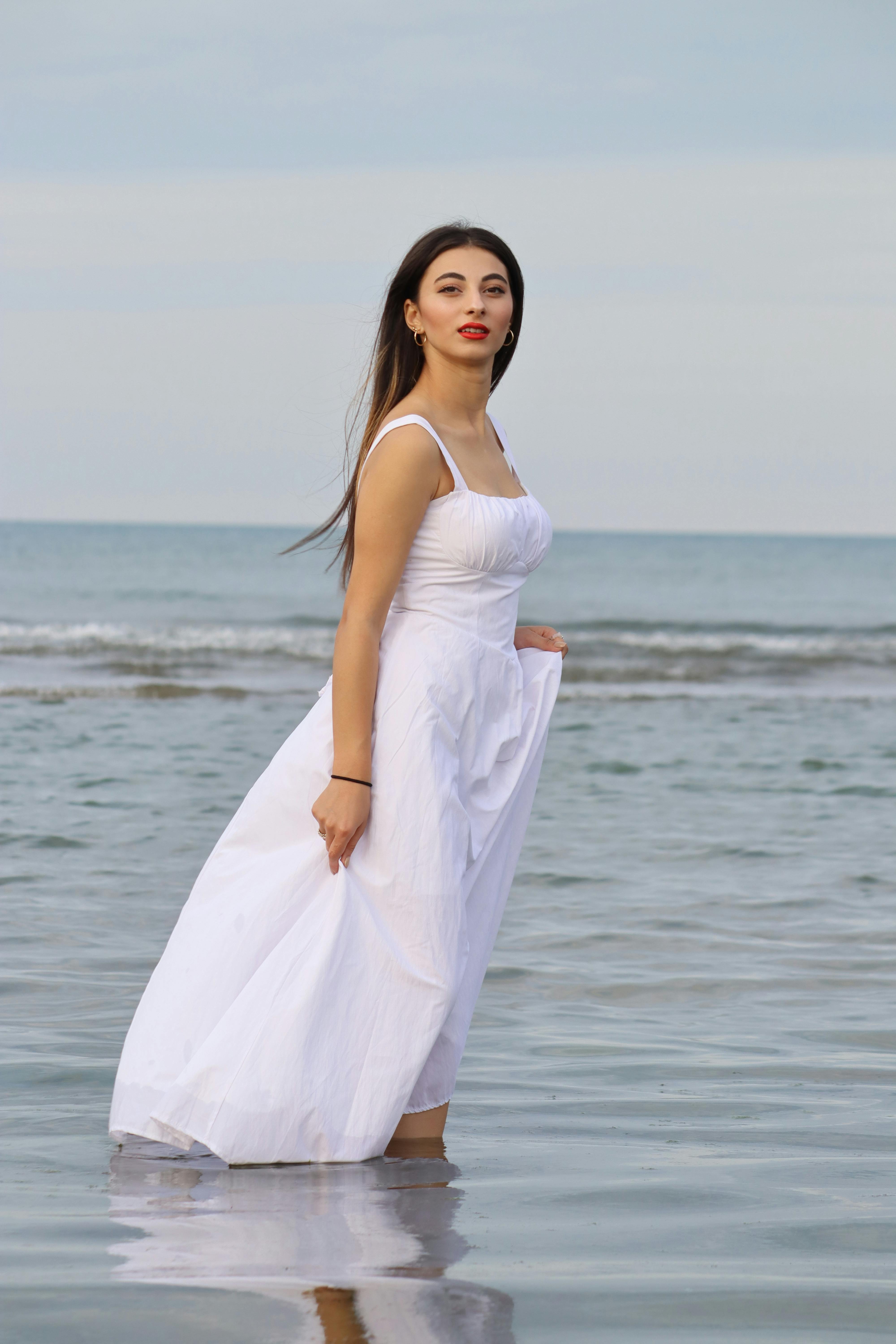 Model in Slit Square Neck Sundress Standing Barefoot on the Beach ...