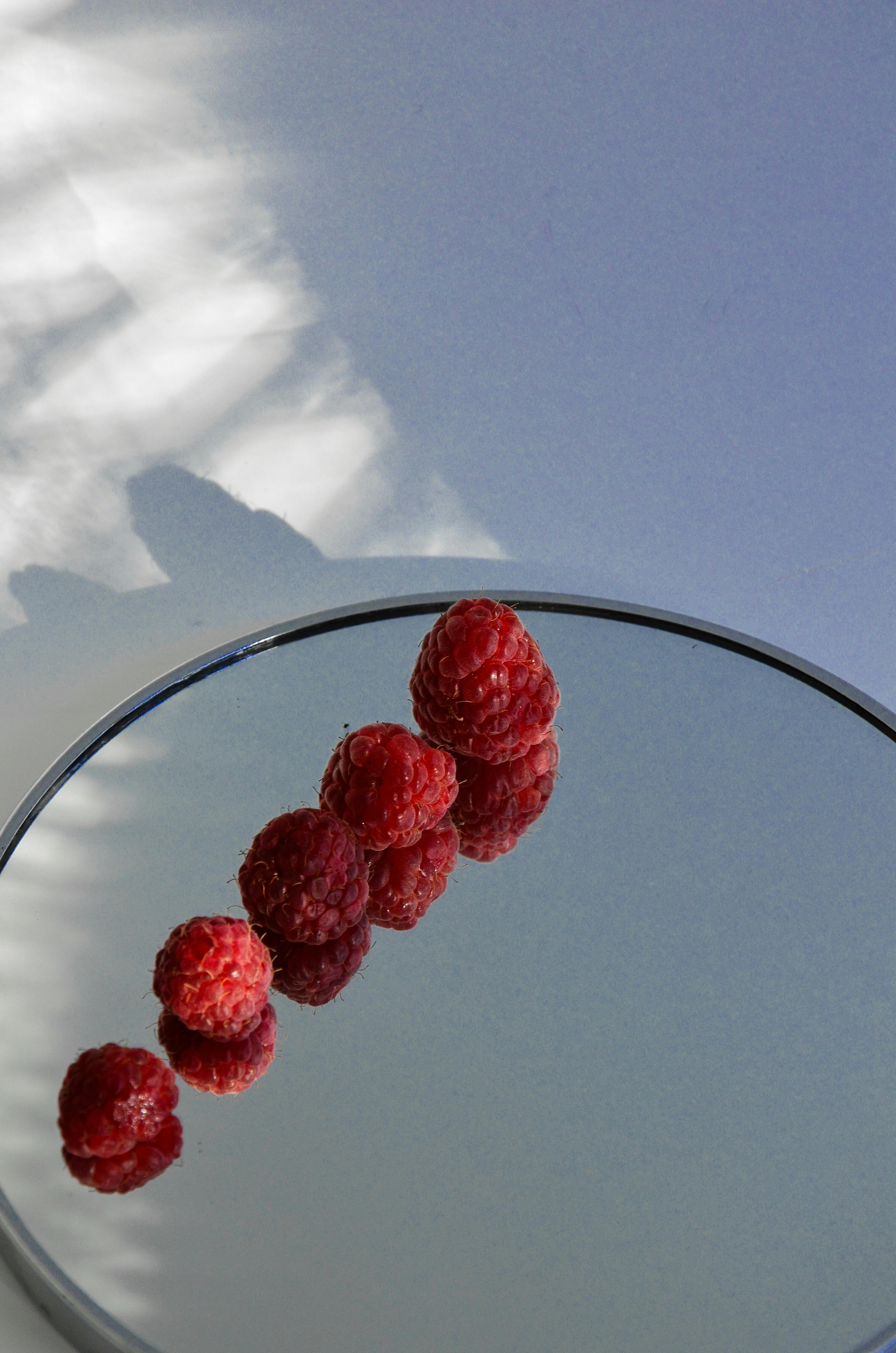Raspberries Lying on a Mirror · Free Stock Photo