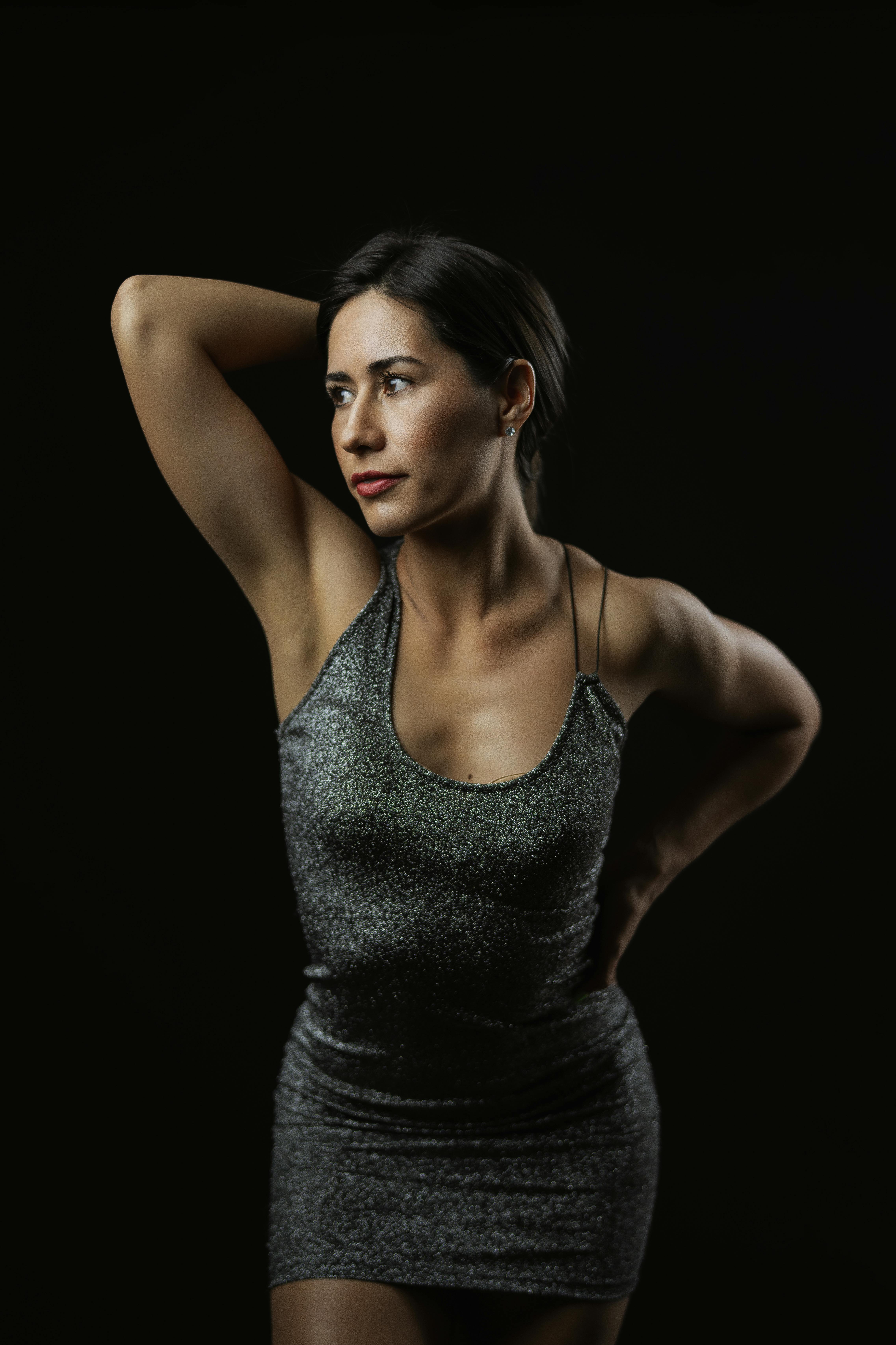 Standing Woman with Raised Hand · Free Stock Photo