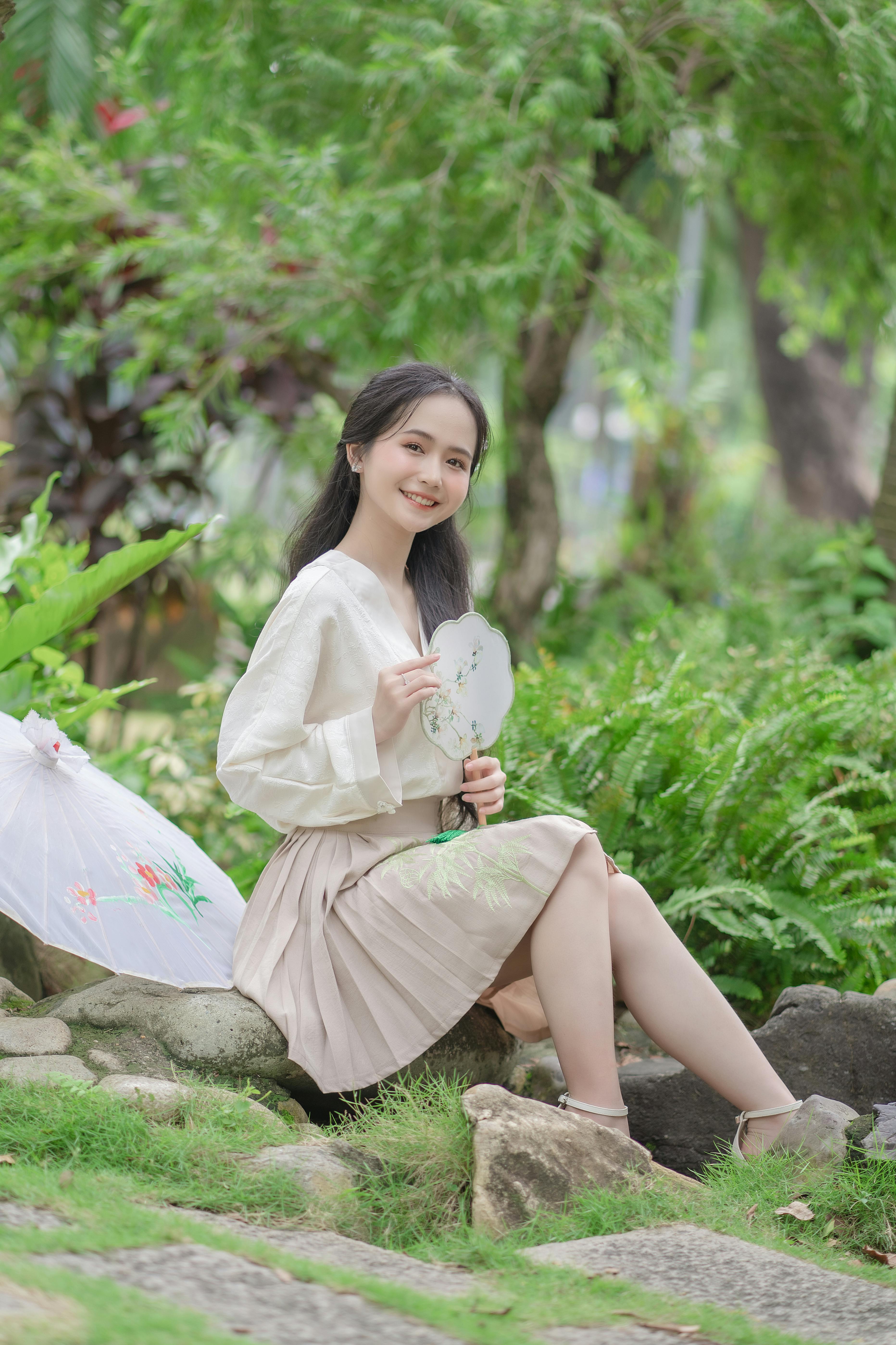 Woman in White Blouse and Beige Skirt Posing with Tuanshan Fan · Free ...