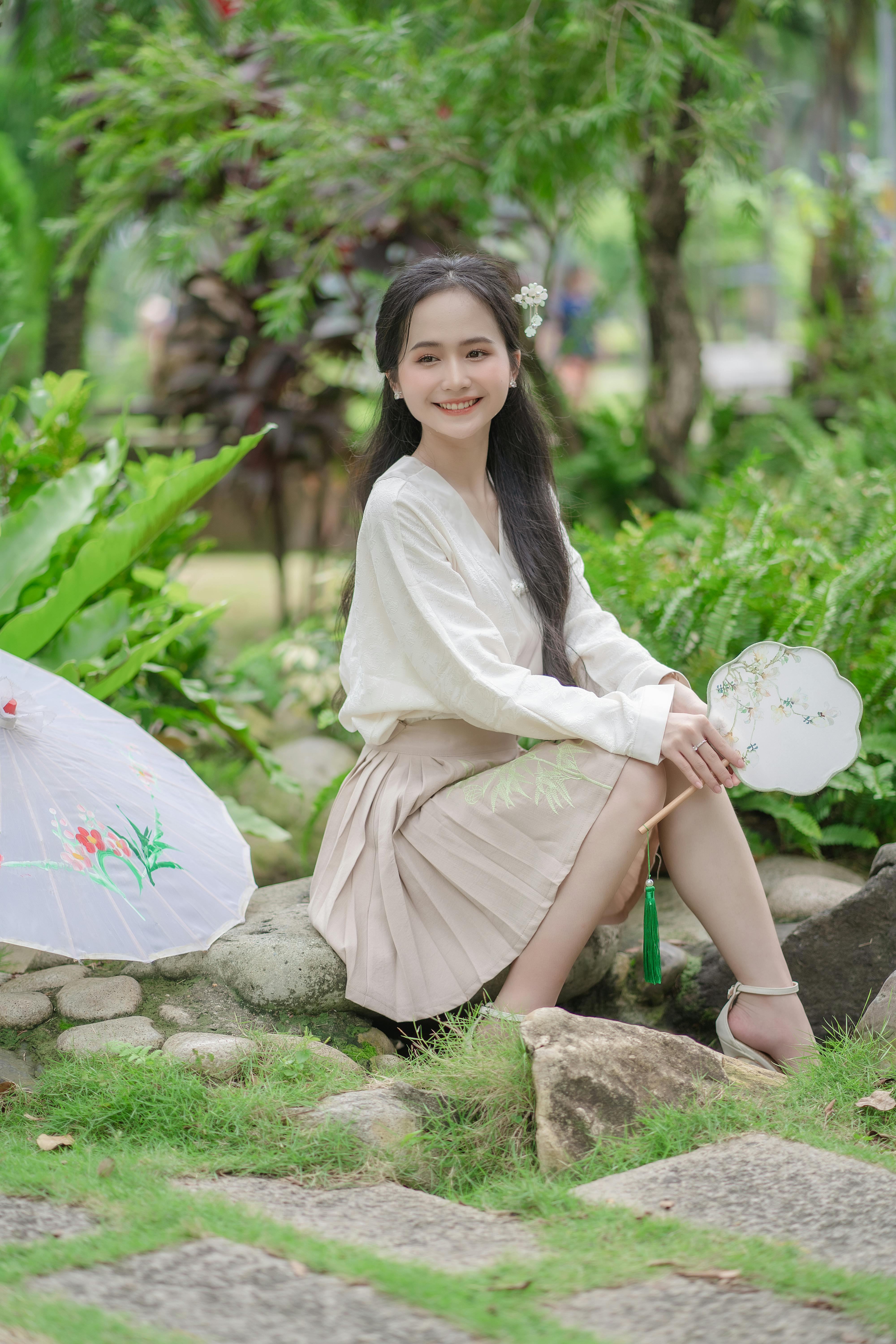 Woman in White Blouse and Beige Skirt Posing with Tuanshan Fan · Free ...