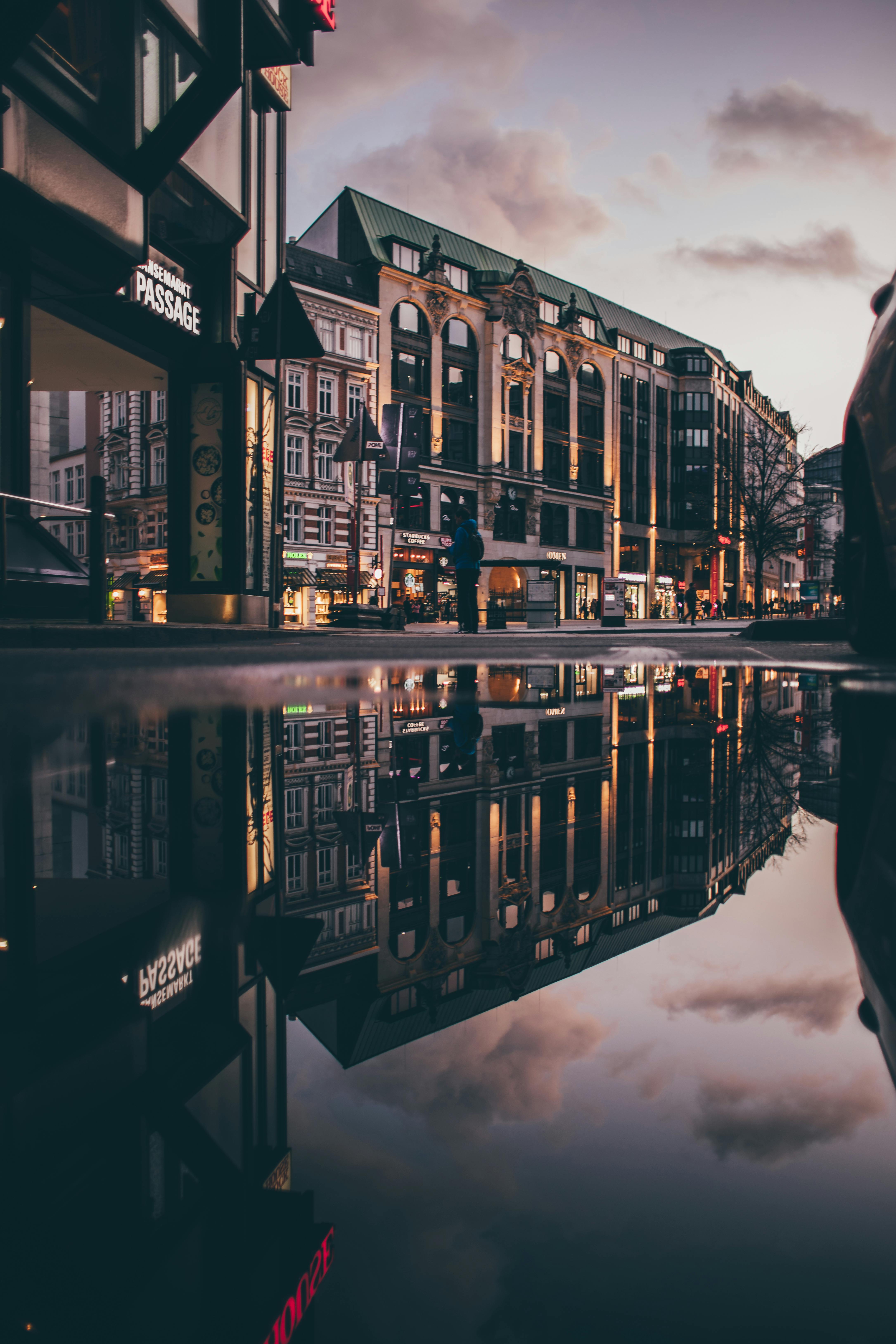 Old City Buildings Reflection in Puddles on Street · Free Stock Photo