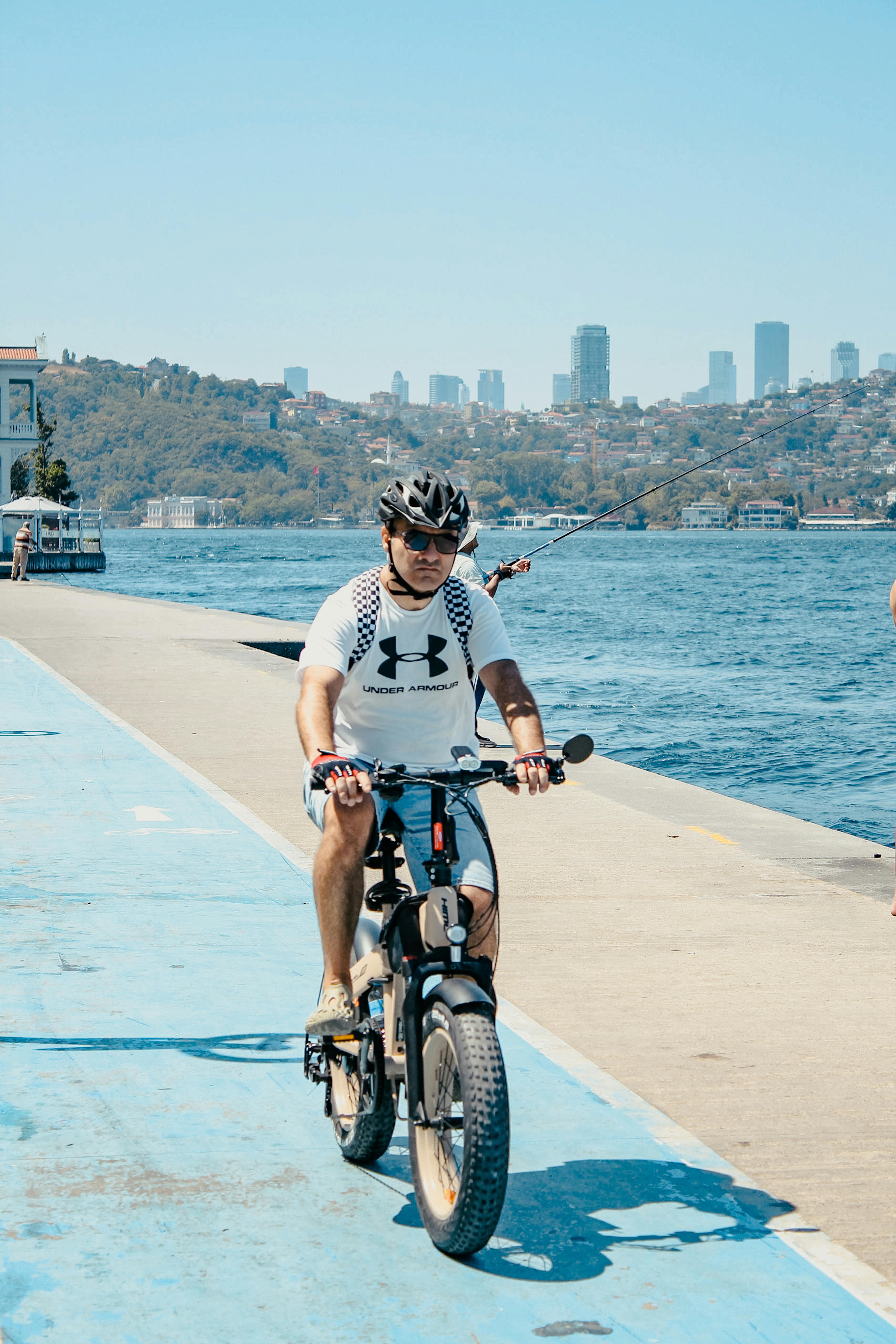 A man riding a bike on the water near a pier · Free Stock Photo