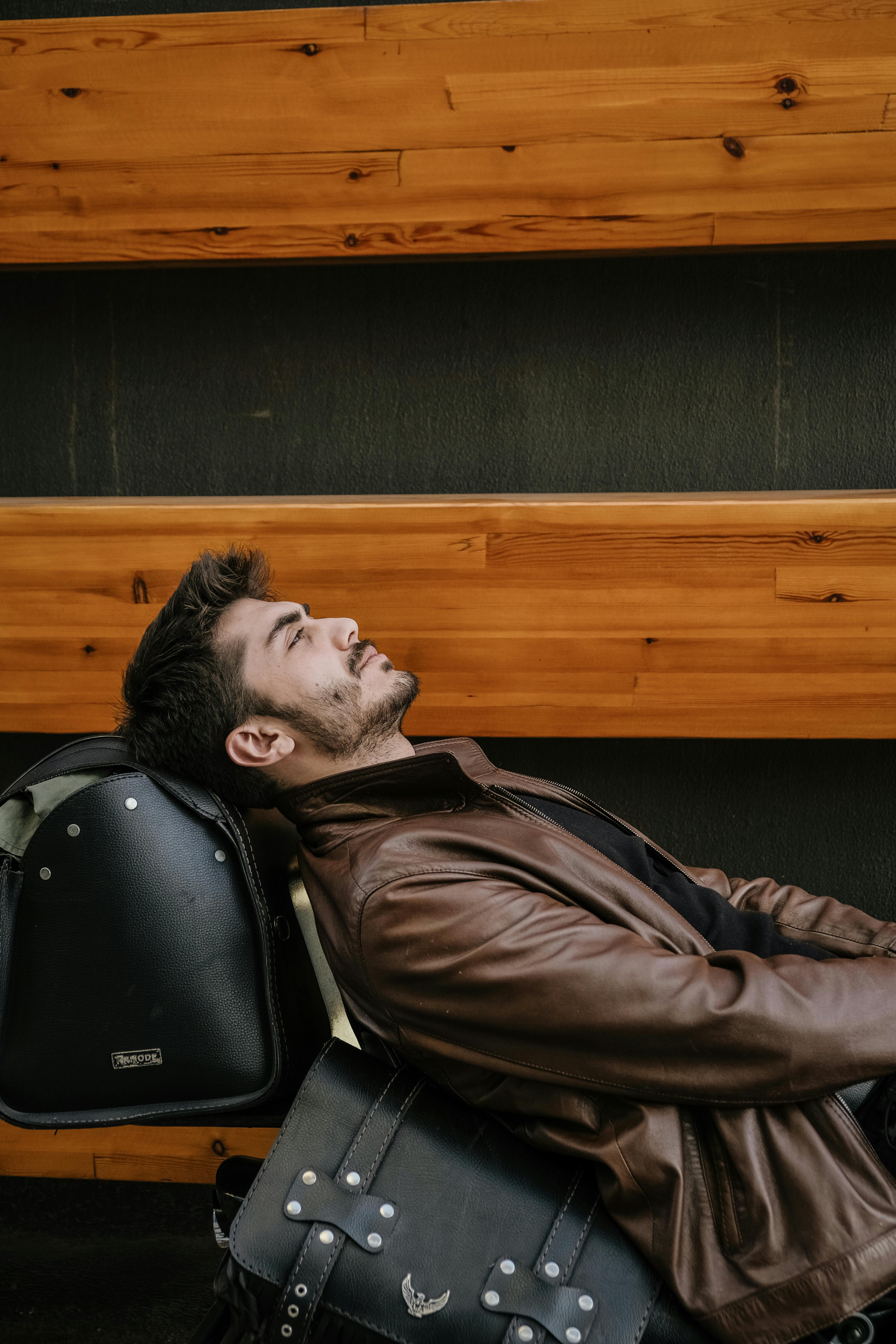 Man in a Leather Jacket Lying on a Motorcycle · Free Stock Photo