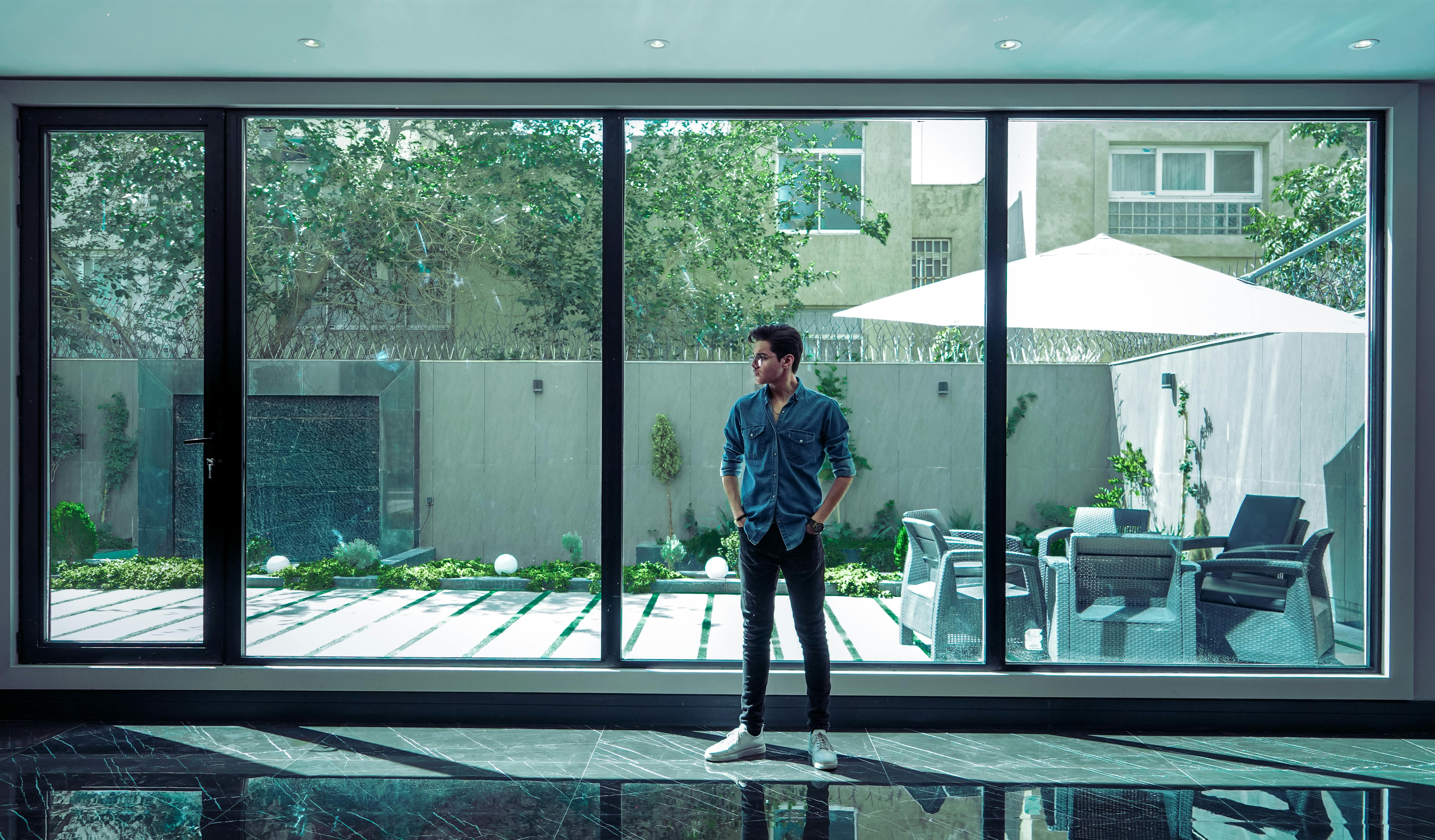 Low-angle Photo of Man Standing Near Light Pole Pointing Down · Free ...