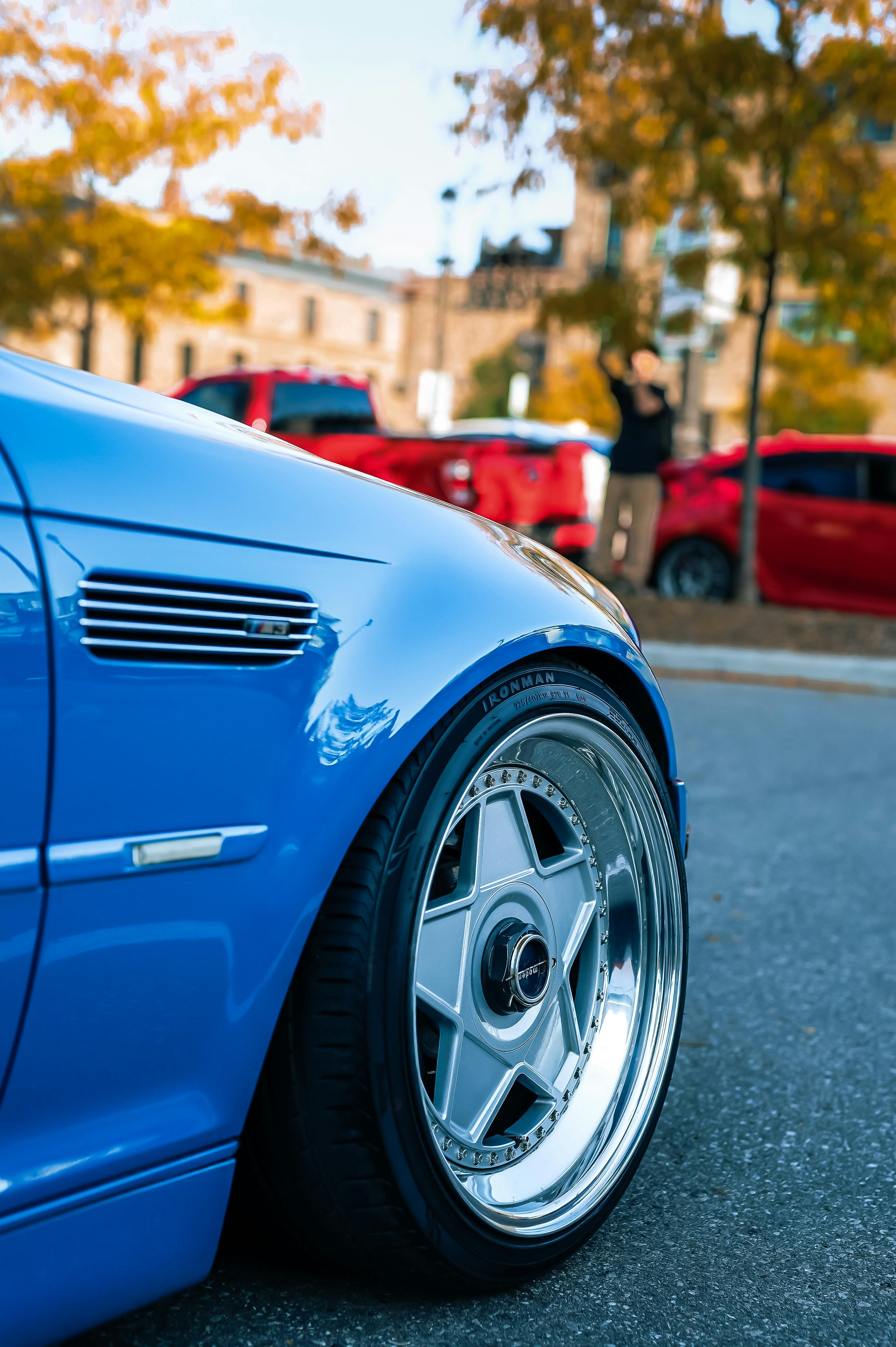 A blue car with rims on it · Free Stock Photo
