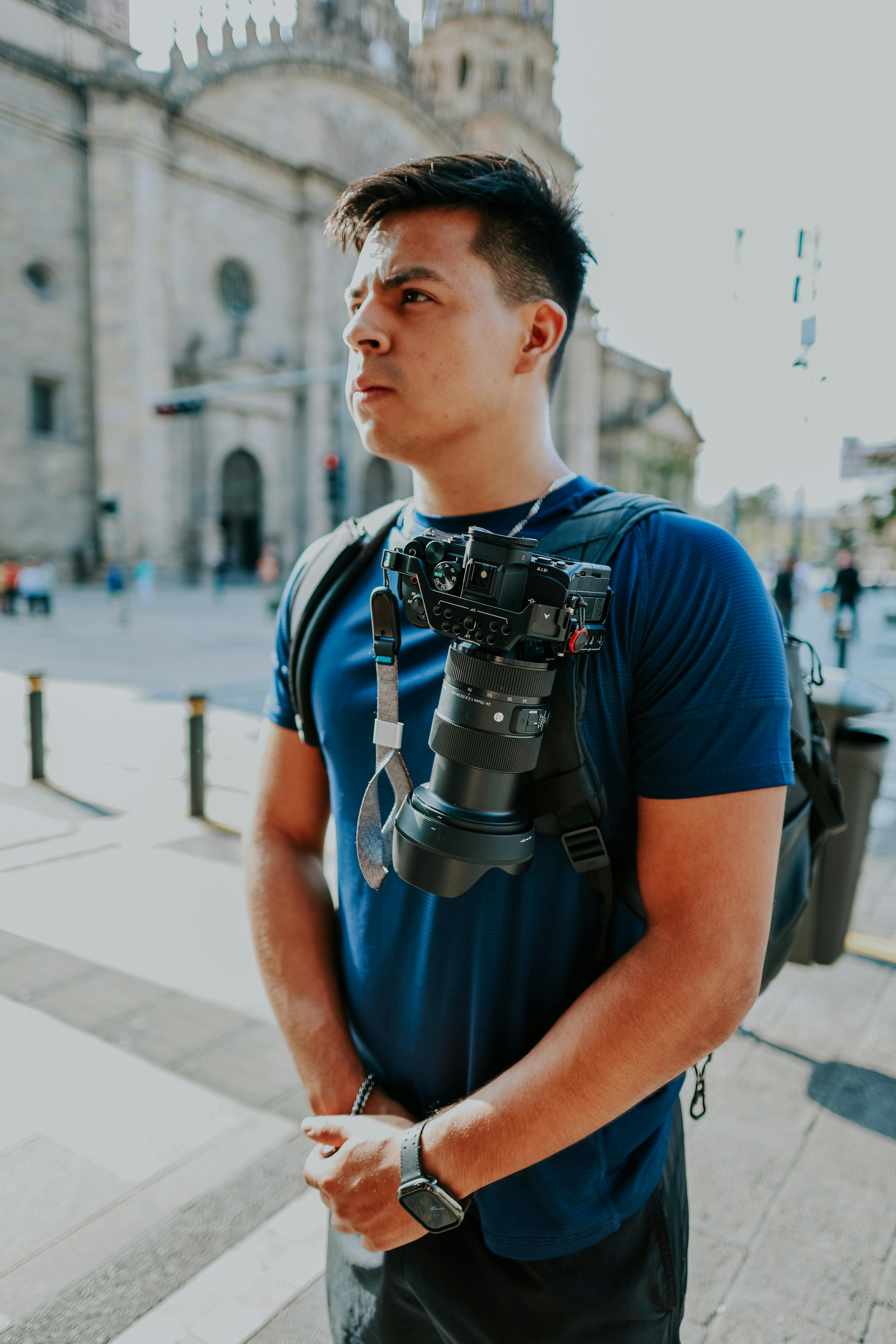 Man with camera walking down street · Free Stock Photo
