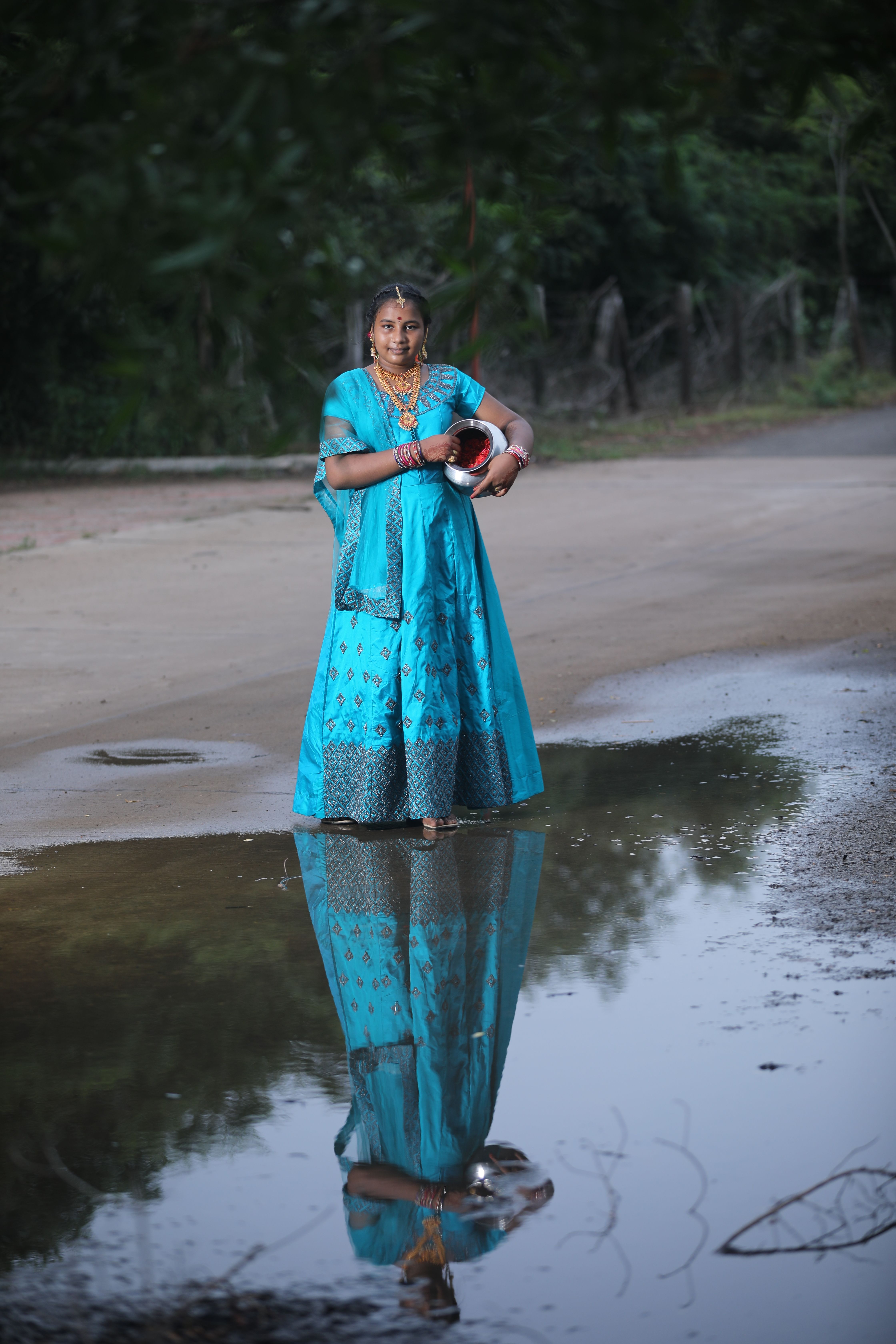 Woman in an Elegant Blue Dress and Her Reflection in a Puddle on the ...
