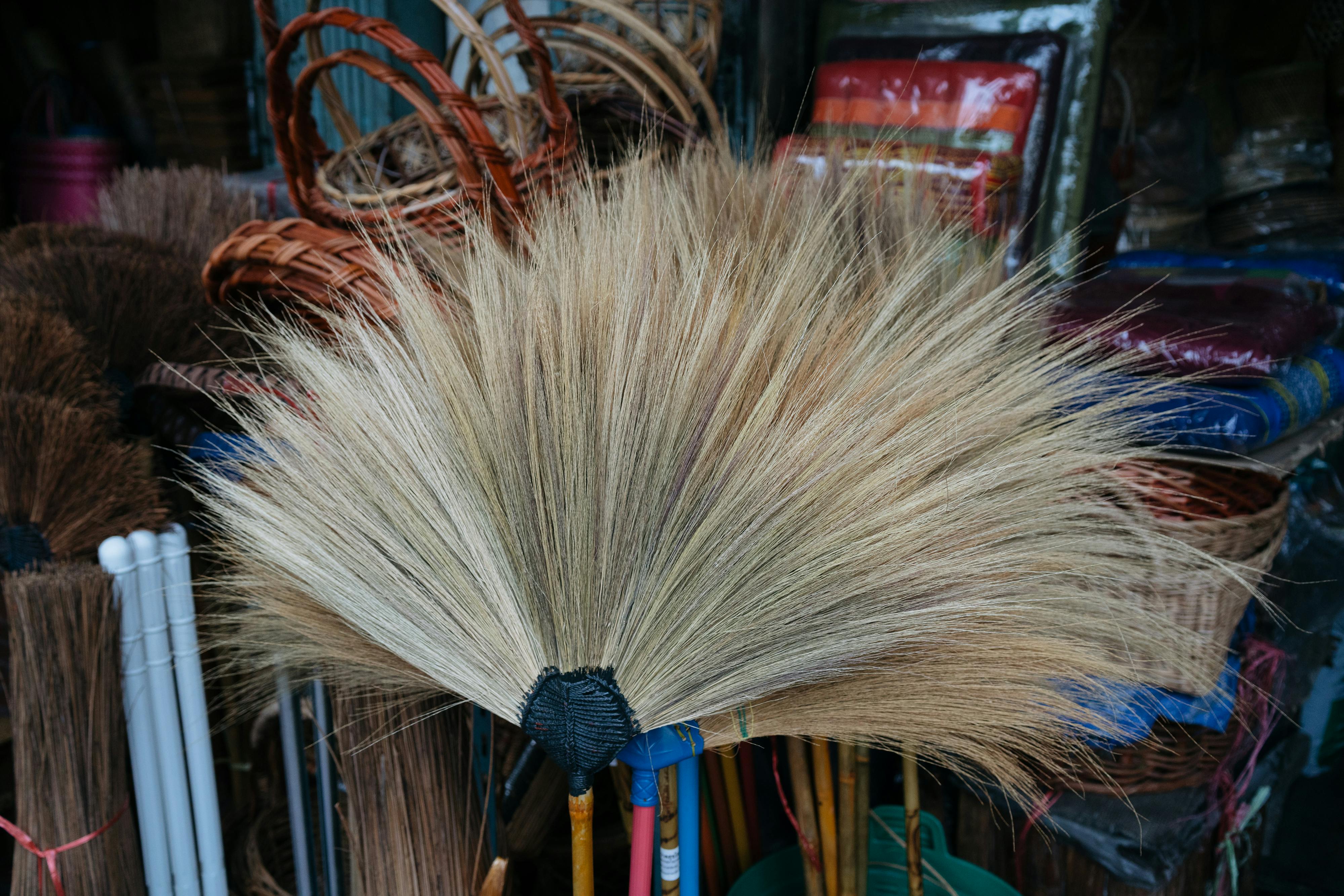 A bunch of different types of brooms are on display · Free Stock Photo
