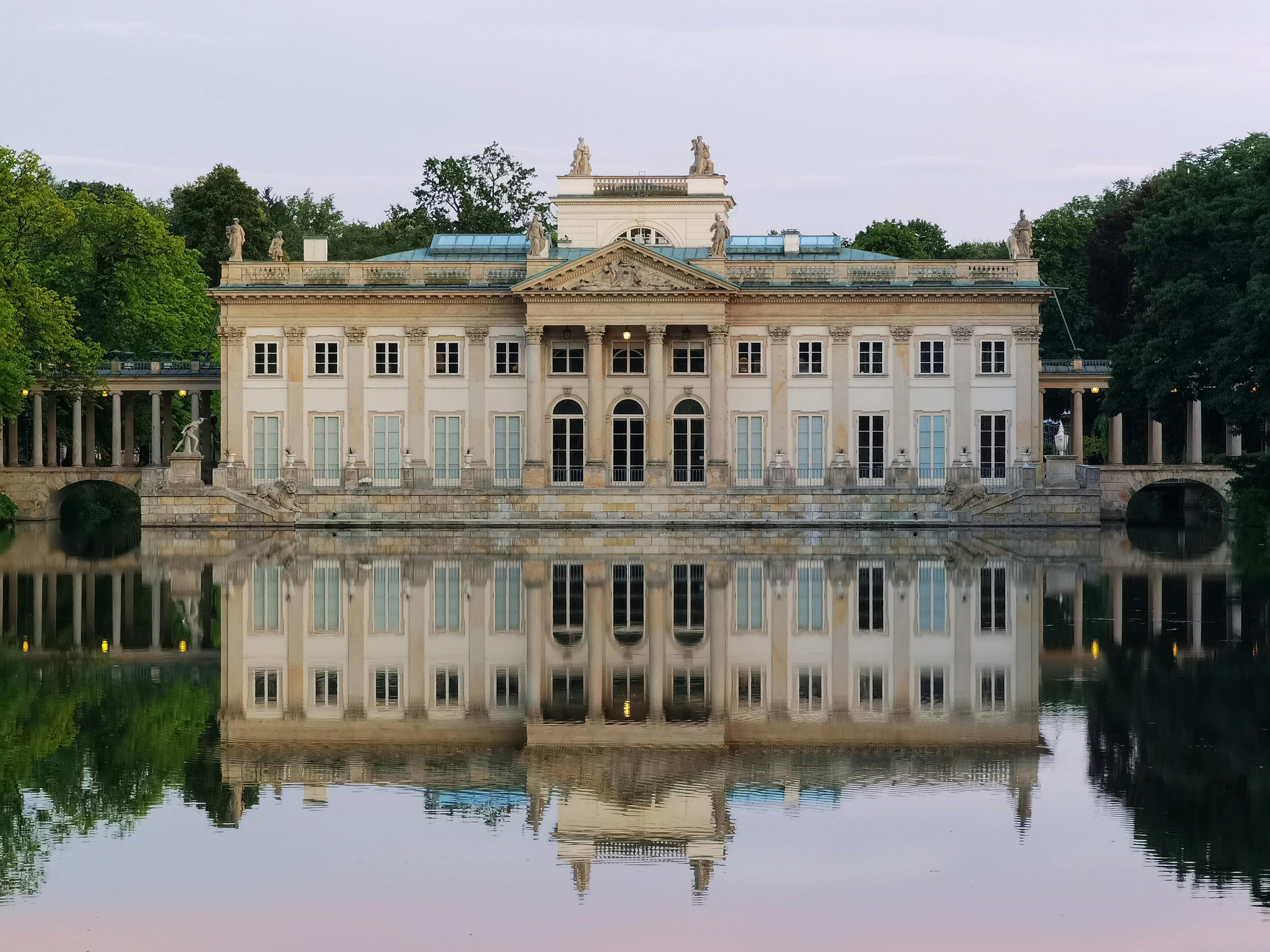 A large mansion with a reflection in the water · Free Stock Photo