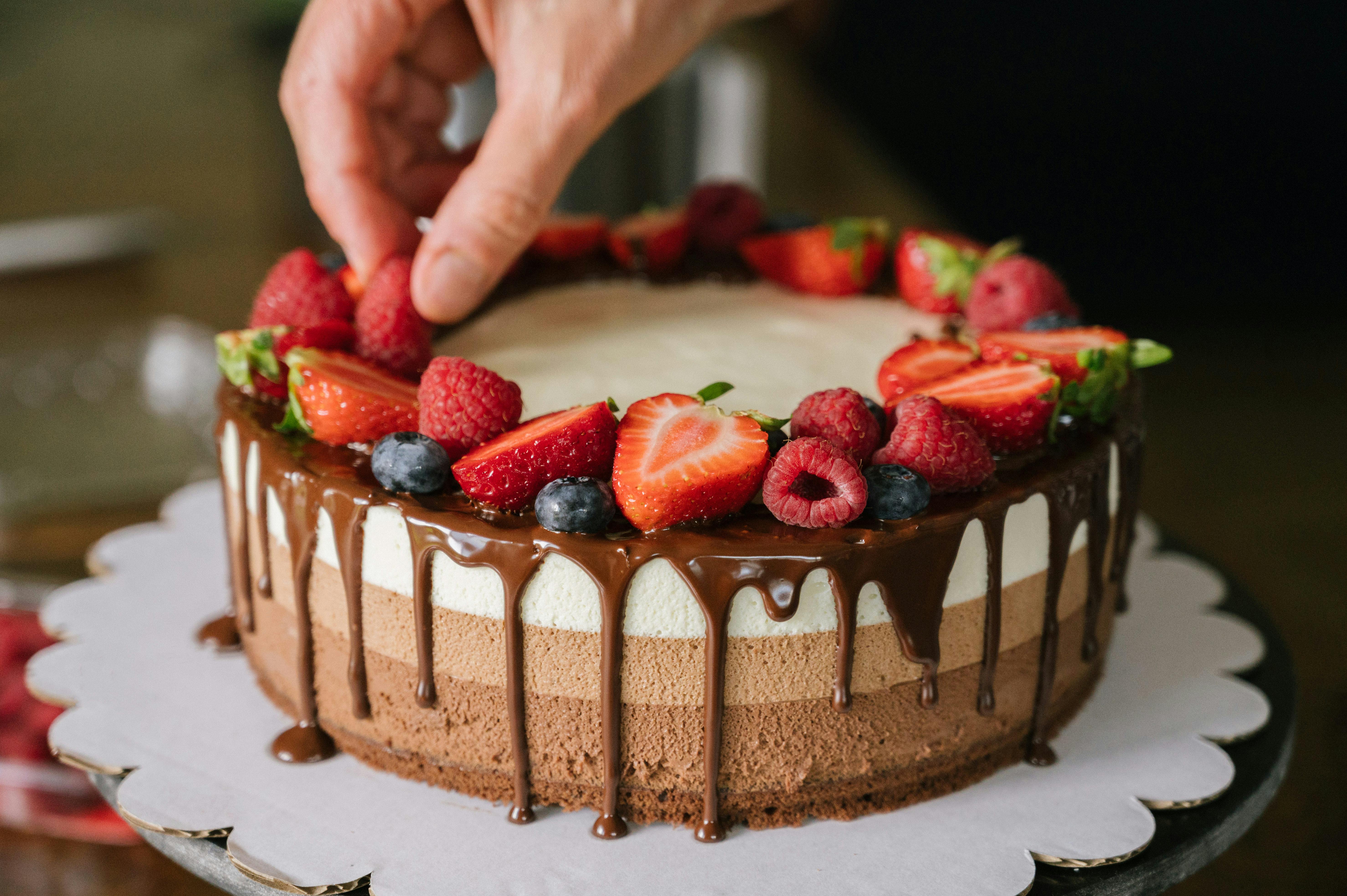 Hand and Cake with Fruit · Free Stock Photo