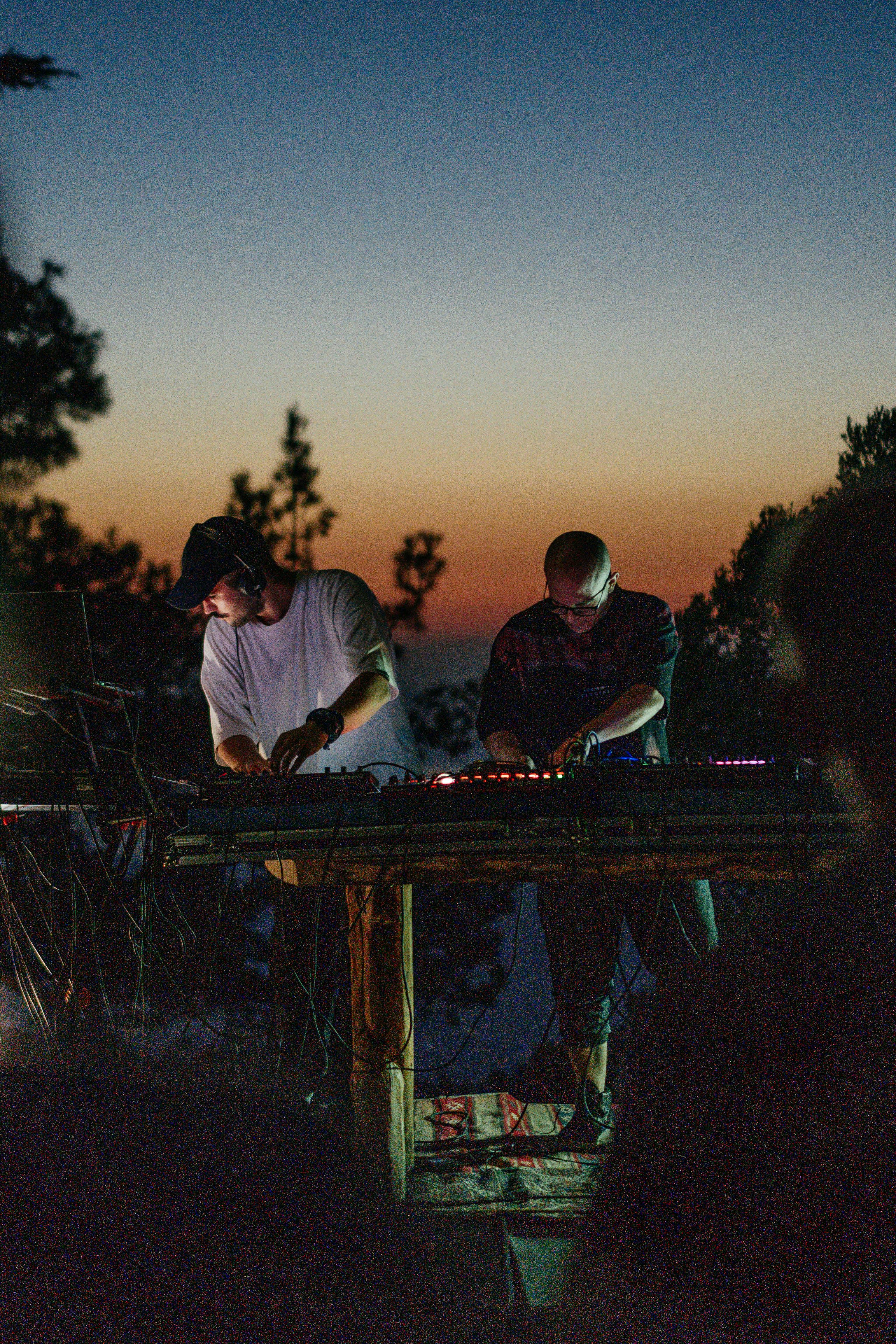 DJs behind the Consoles at a Party Outside · Free Stock Photo
