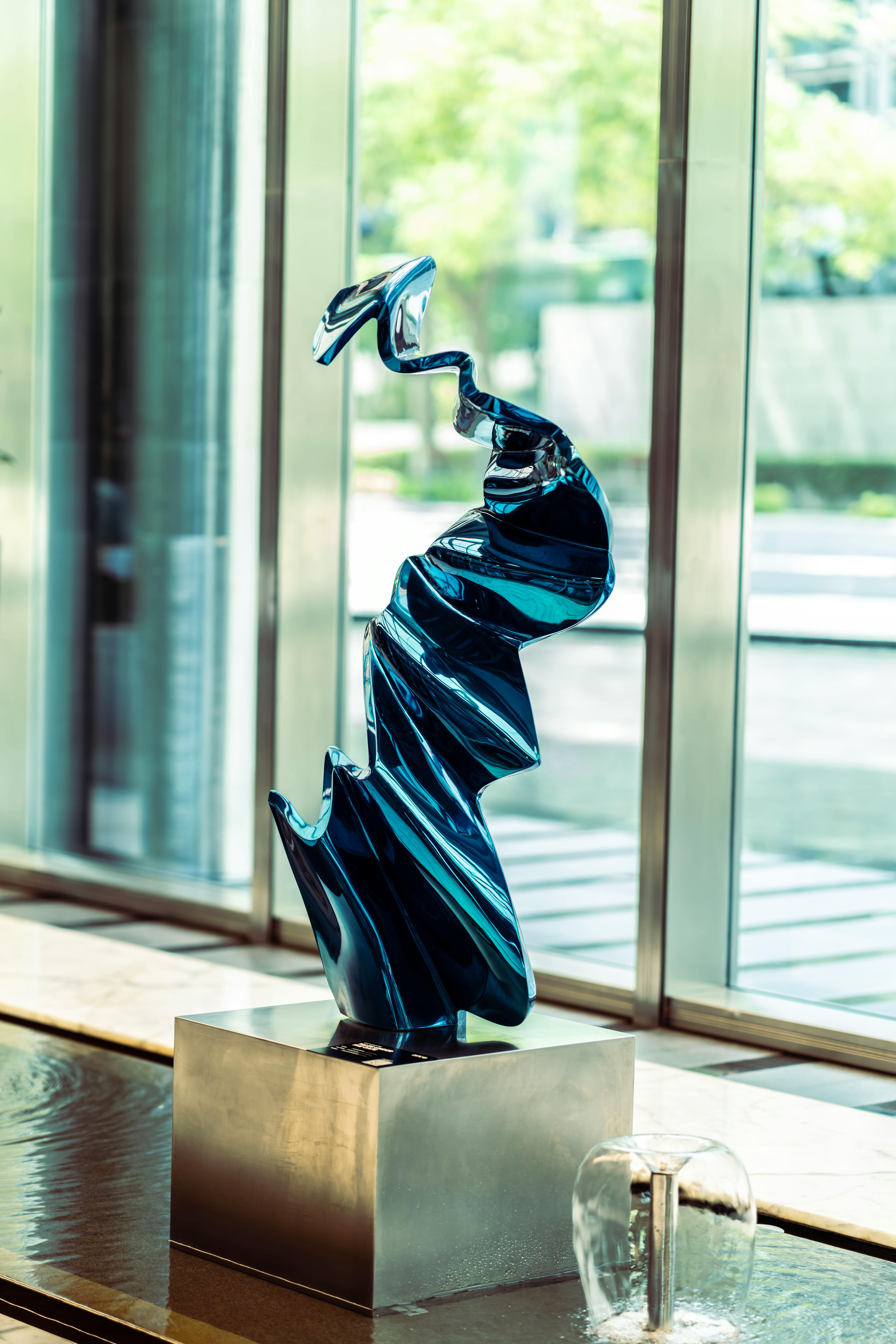 Futuristic Statue near Windows · Free Stock Photo