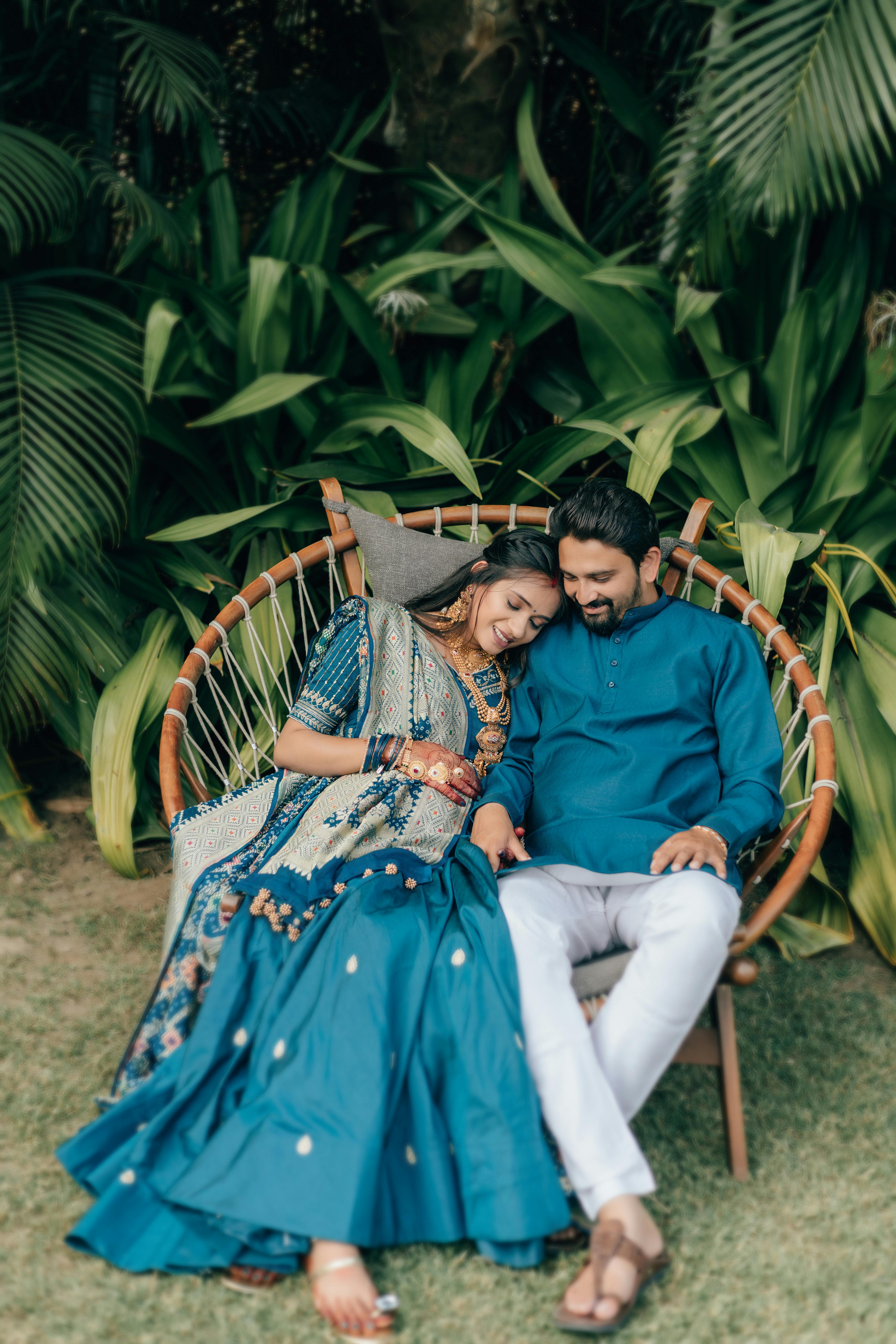 Smiling Couple Sitting in Traditional Clothing · Free Stock Photo