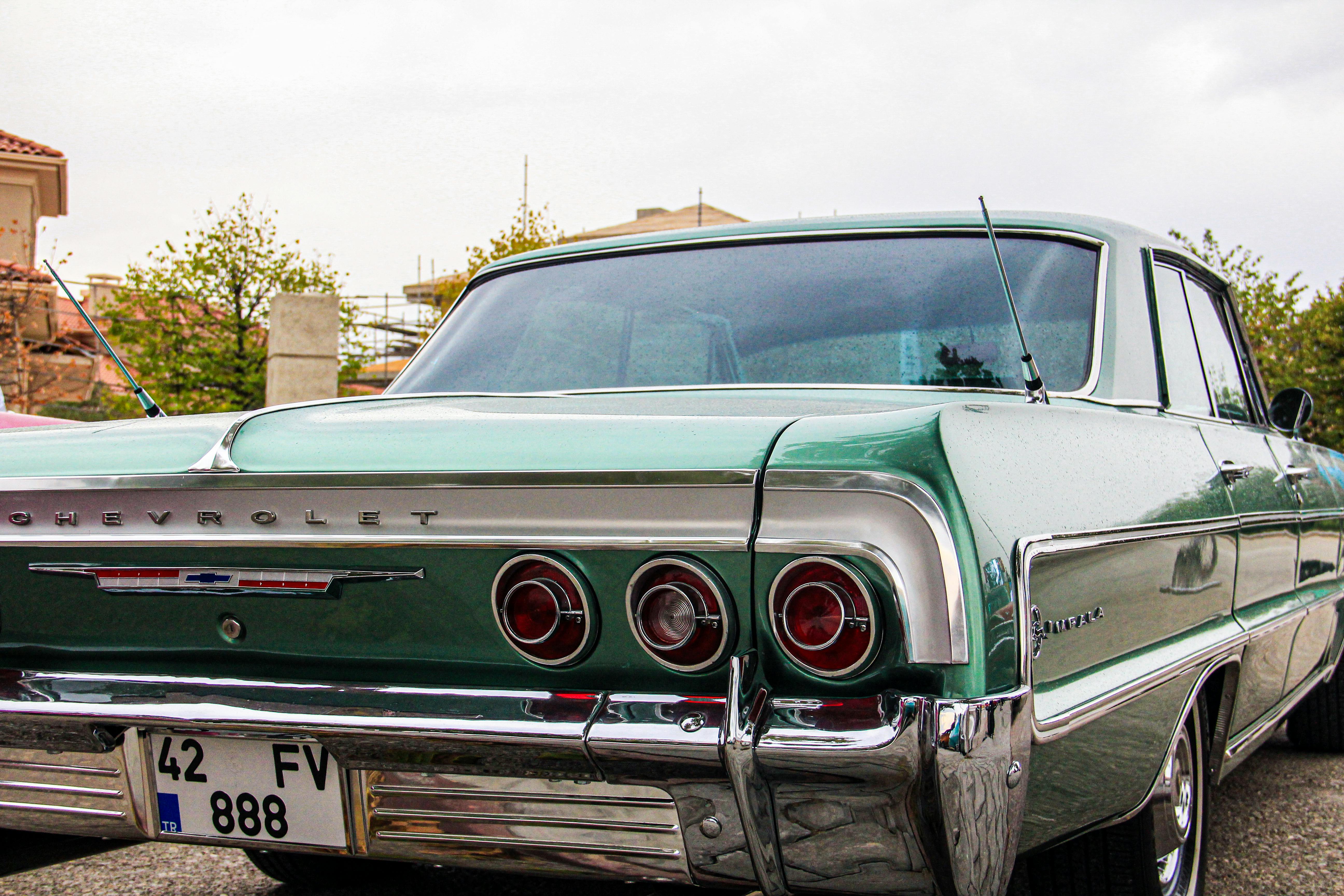 Rear View of Green Vintage Chevrolet Impala Car · Free Stock Photo