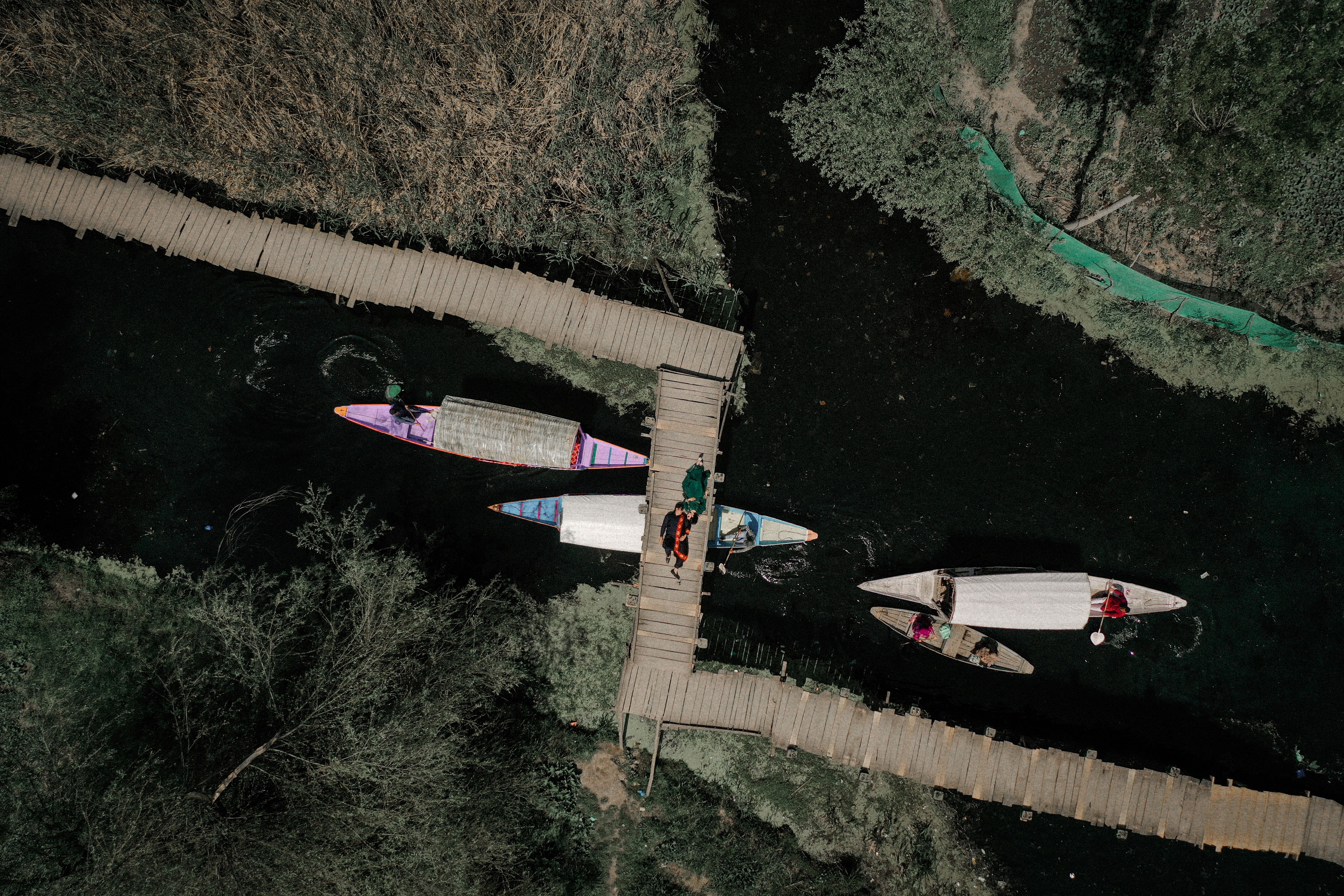 Aerial Footage of Boats and a Wooden Jetty on a River · Free Stock Photo