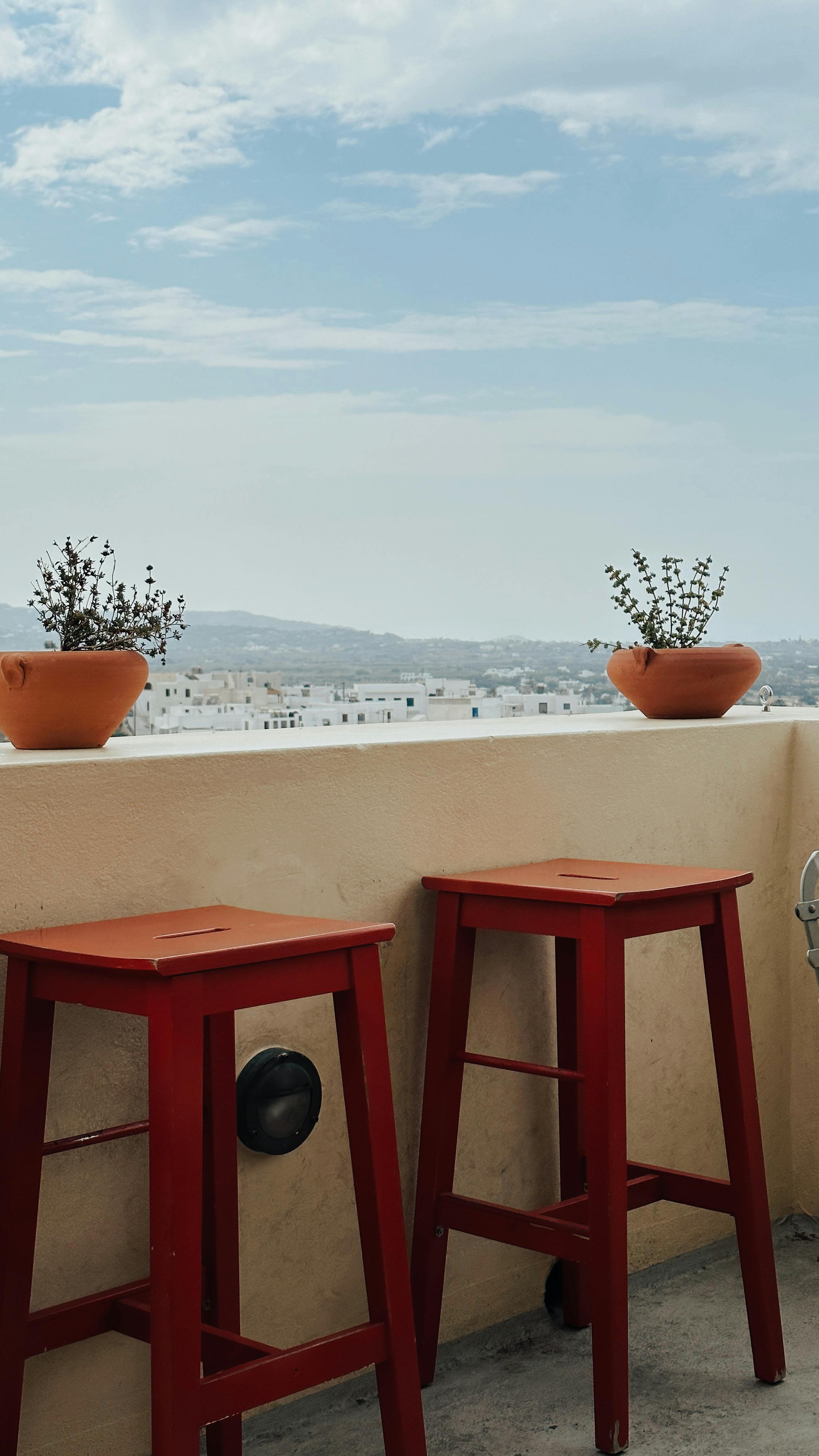 Wooden Bar Stools by Balcony Wall · Free Stock Photo