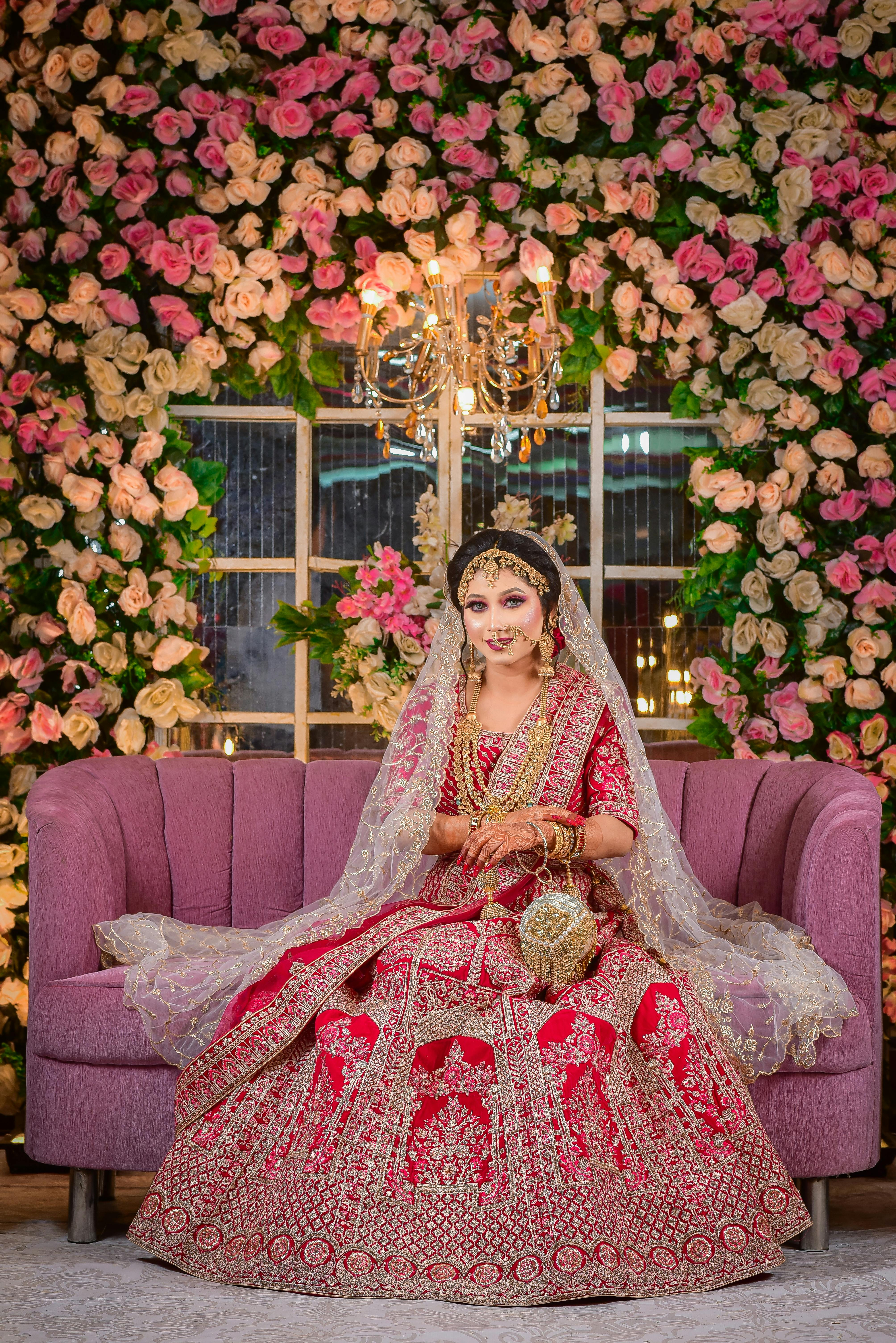 Woman in Traditional Wedding Dress Sitting on Couch · Free Stock Photo