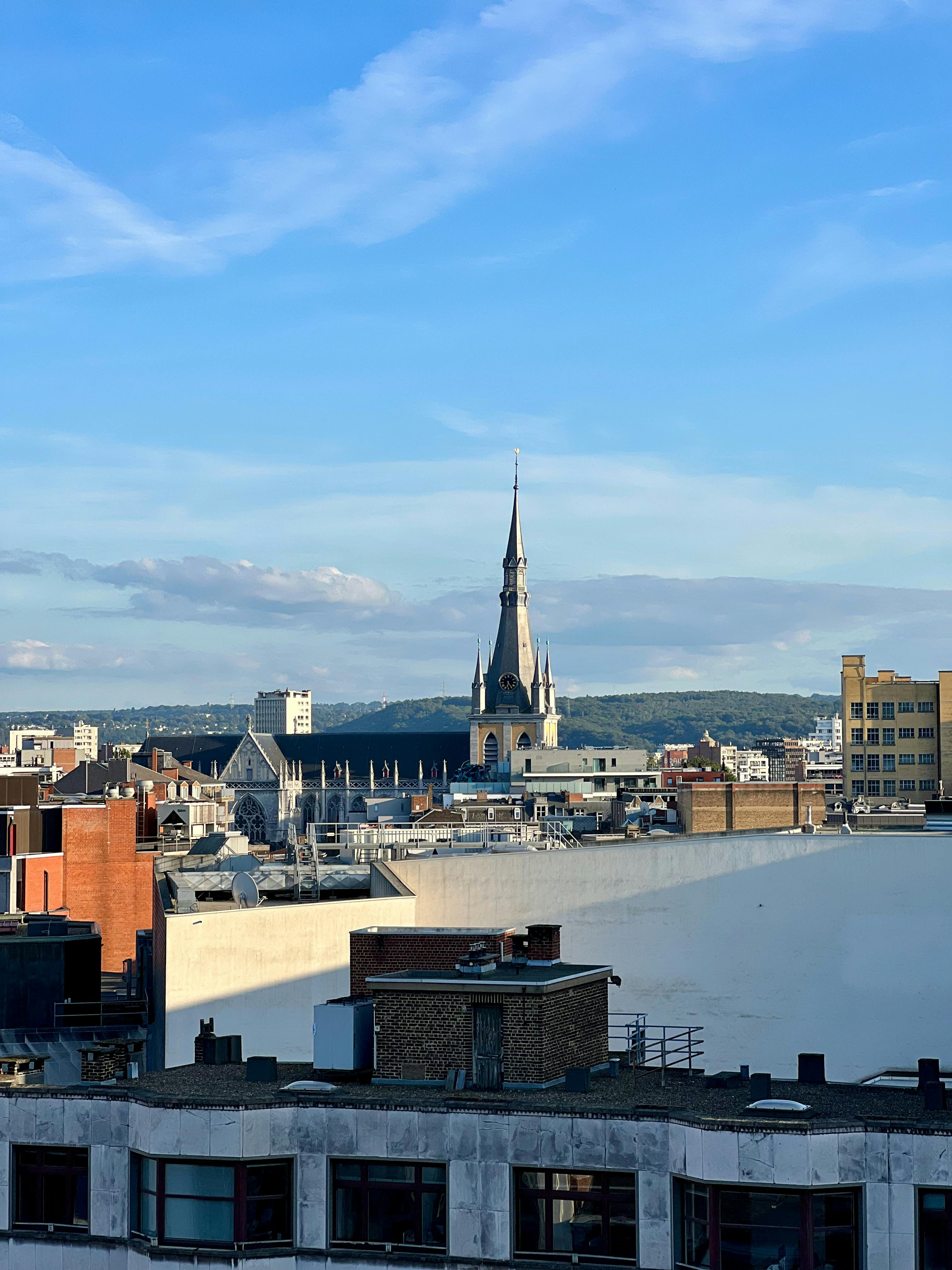 Church Tower over Buildings in City · Free Stock Photo