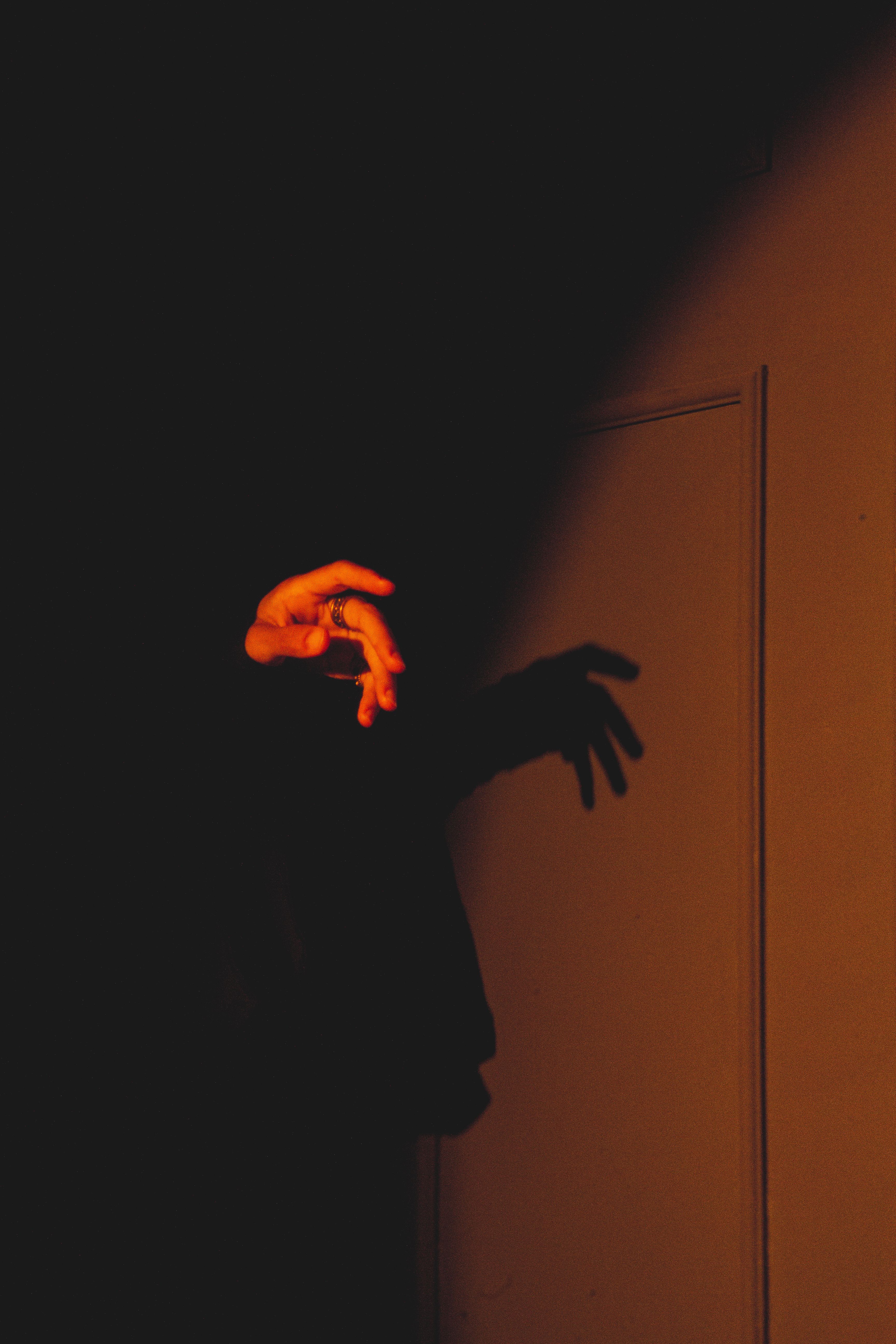 Hand Reaching out from the Shadows · Free Stock Photo