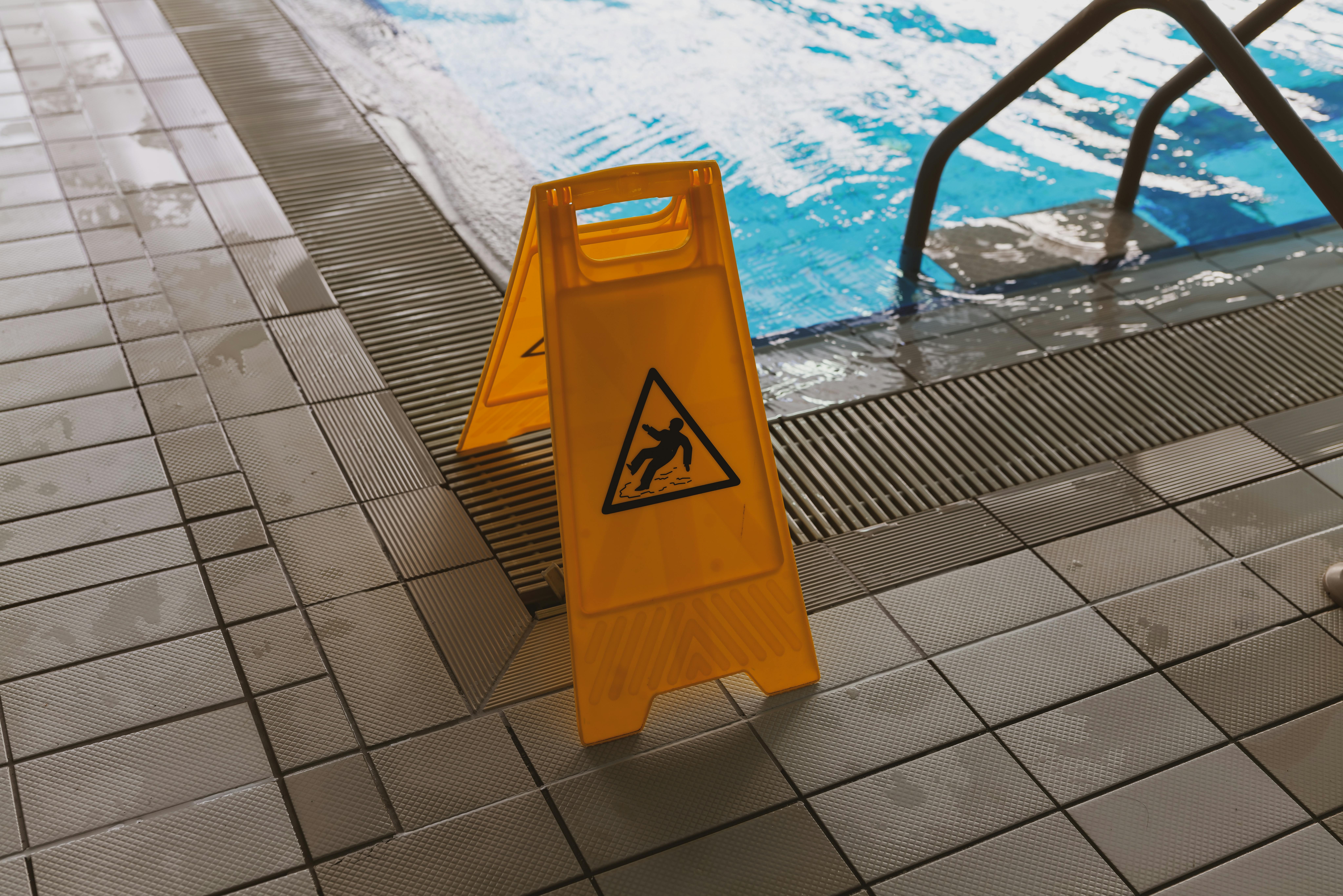Wet Floor Sign near Swimming Pool · Free Stock Photo