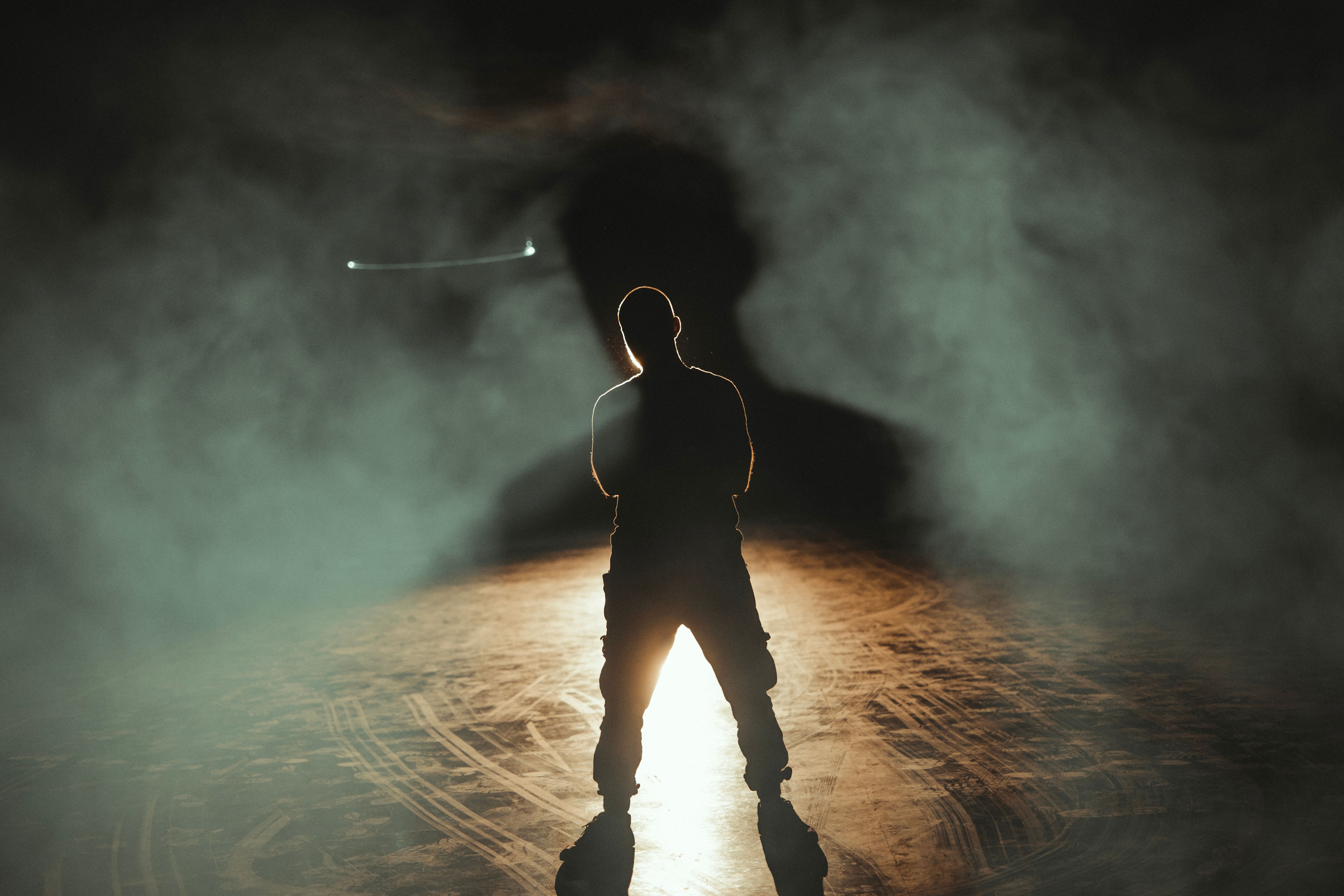 Silhouette of a Man Standing in Smoke · Free Stock Photo