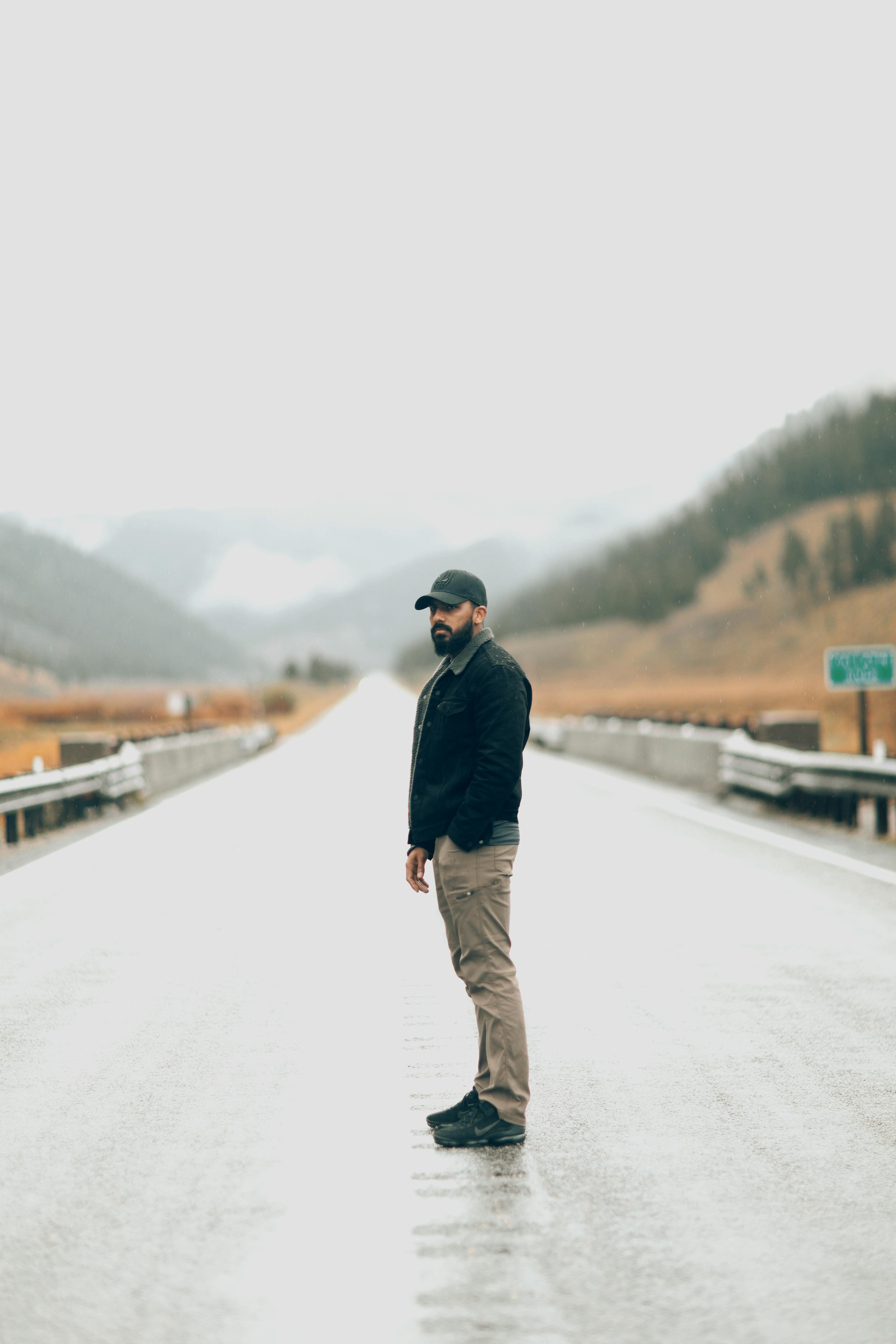 Man in Cap Standing on Road · Free Stock Photo