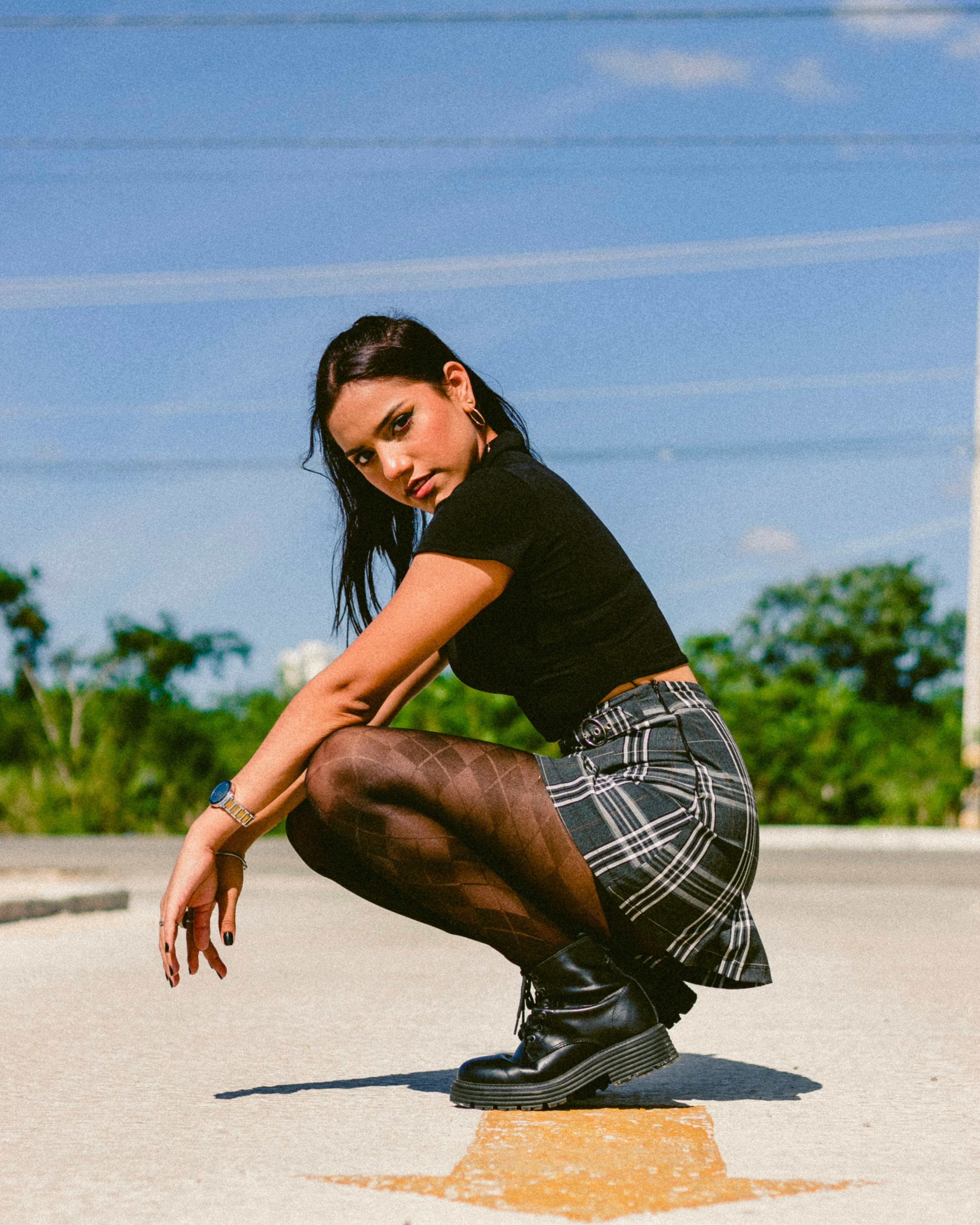 Brunette Model Squatting and Posing · Free Stock Photo