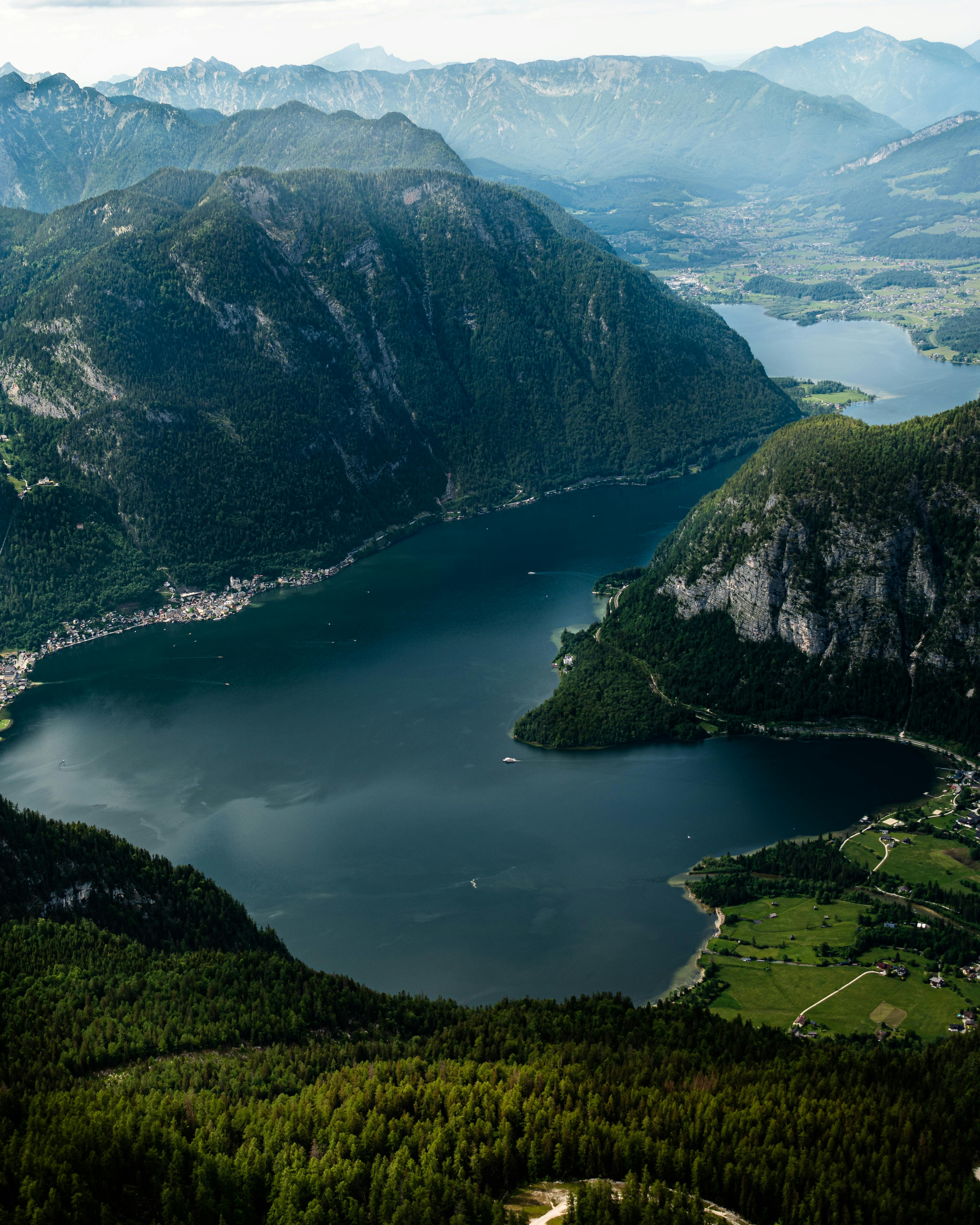 Boat floating on blue tranquil lake in verdant highlands · Free Stock Photo
