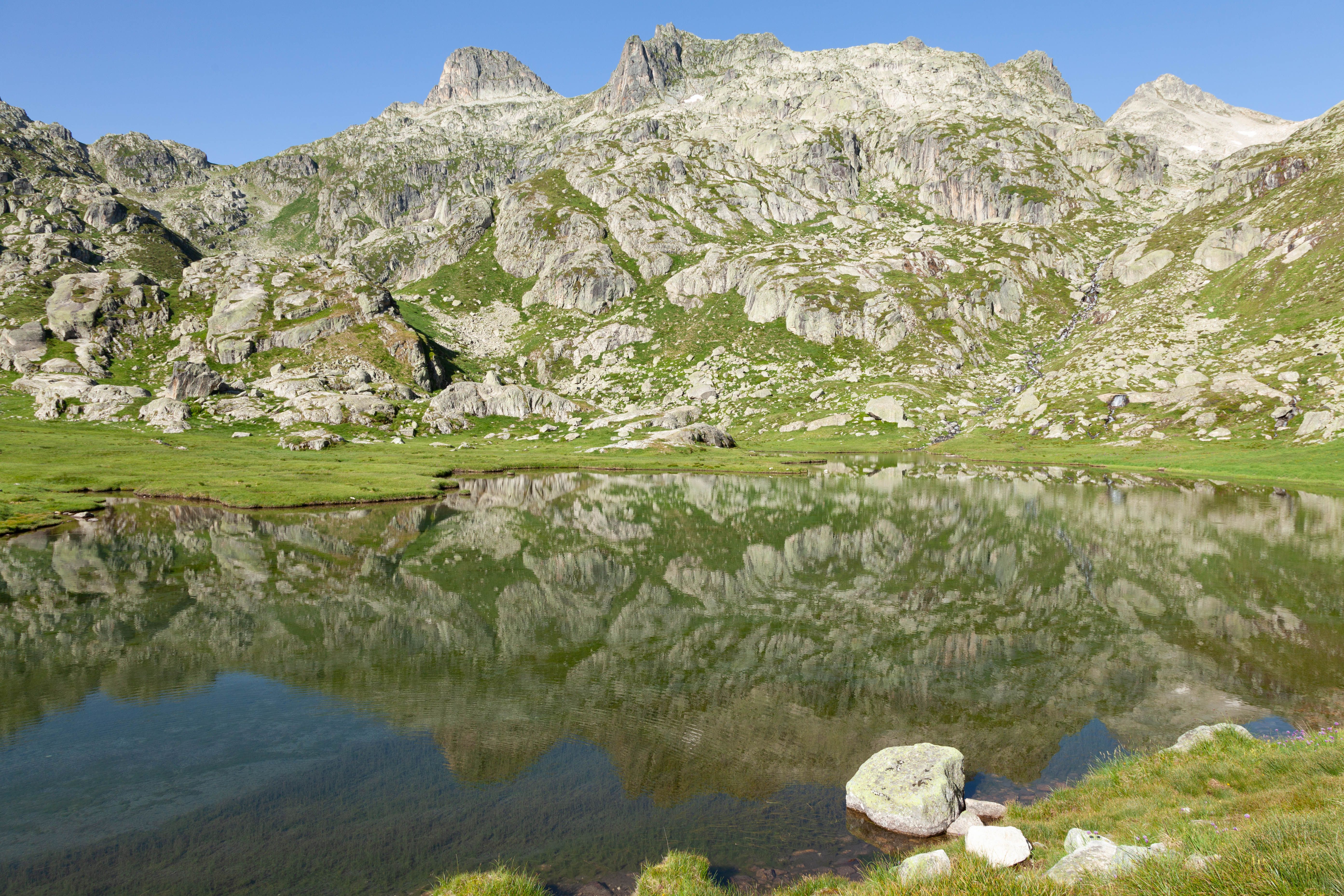 Lake with Rock on Hill behind · Free Stock Photo