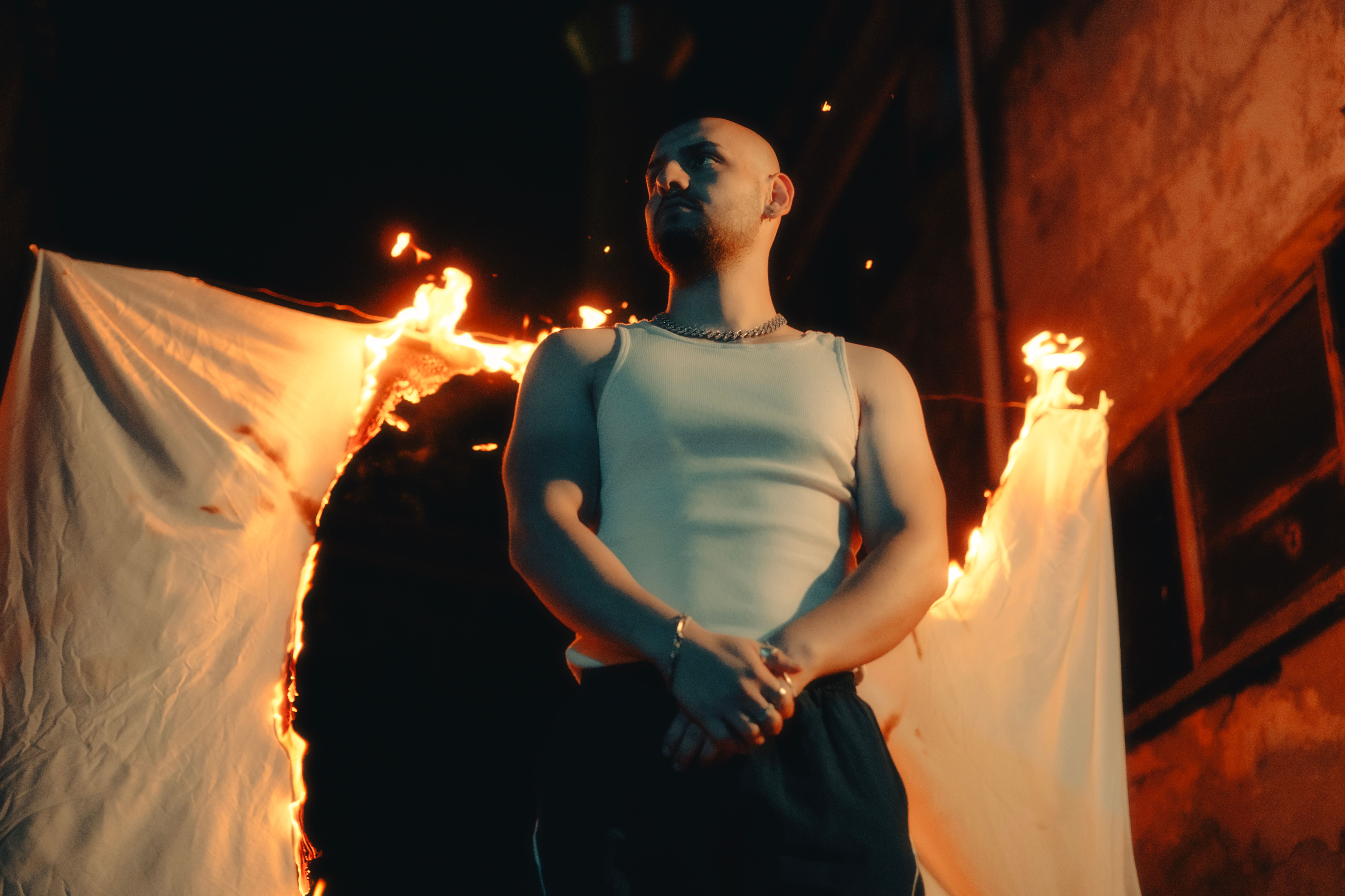 Burning Fabric behind Model in Tank Top at Night · Free Stock Photo